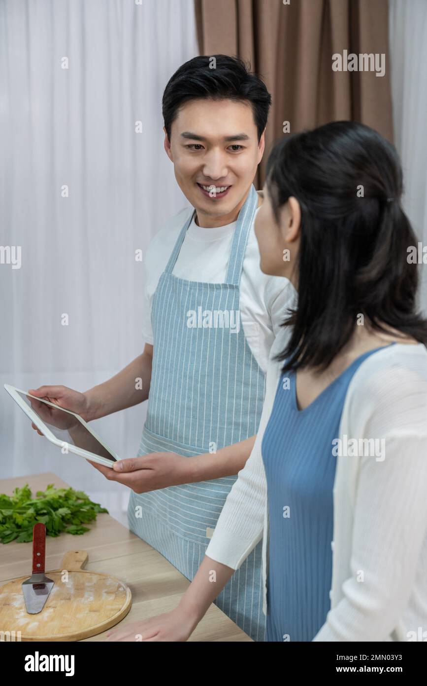 Happy young families making refreshments Stock Photo - Alamy