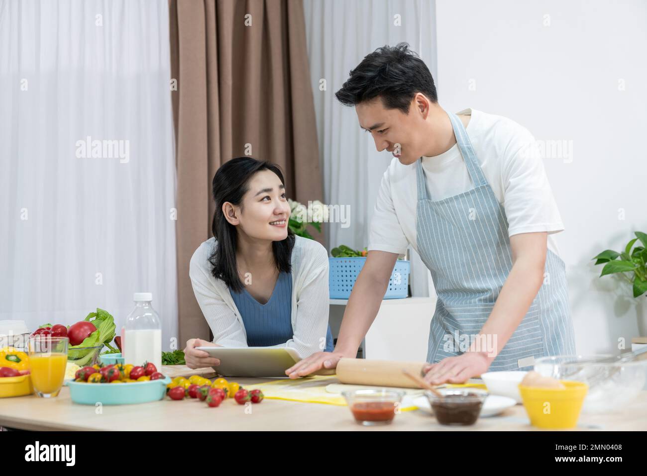 Happy young families making refreshments tablets Stock Photo - Alamy