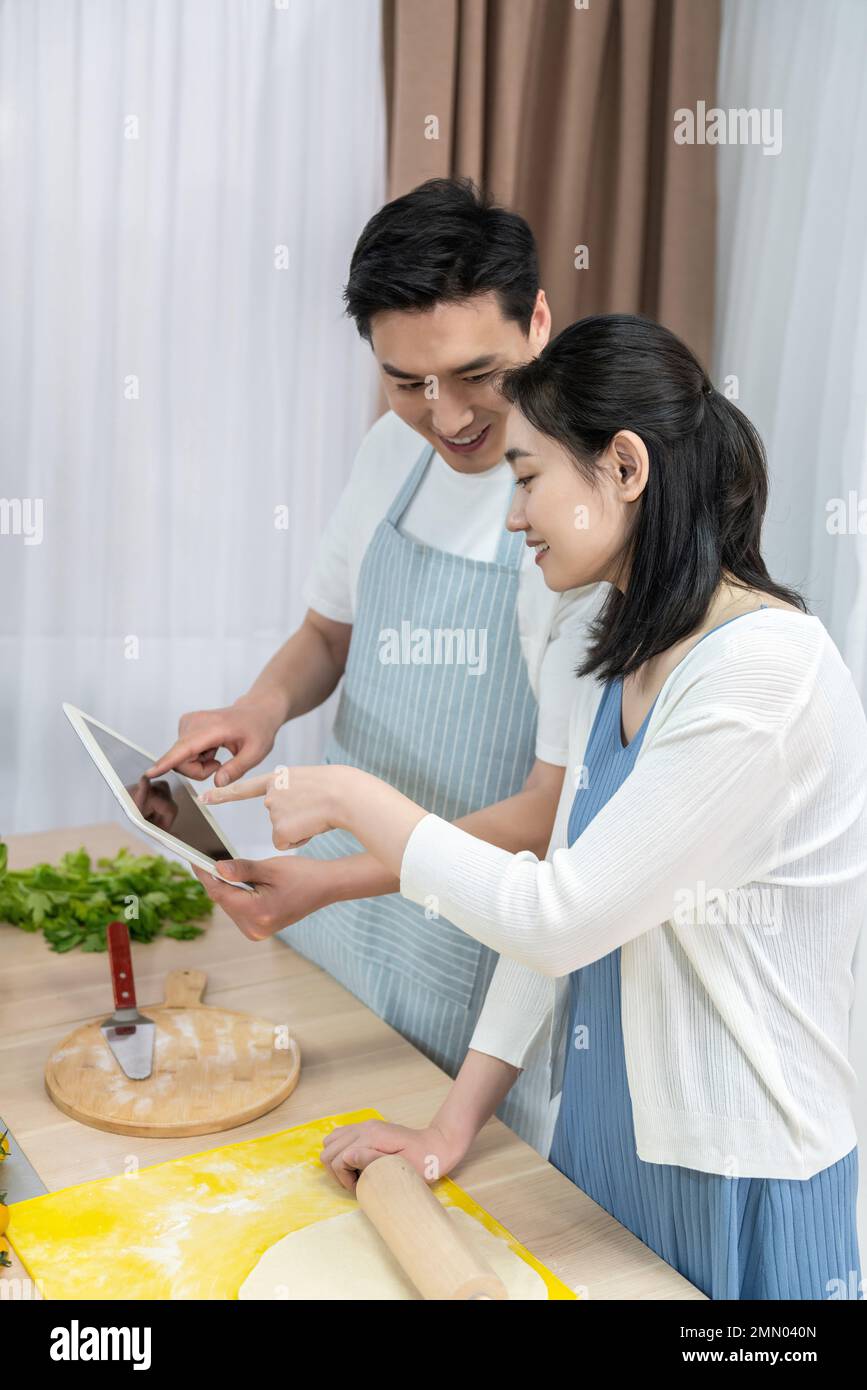 Happy young families making refreshments tablets Stock Photo - Alamy
