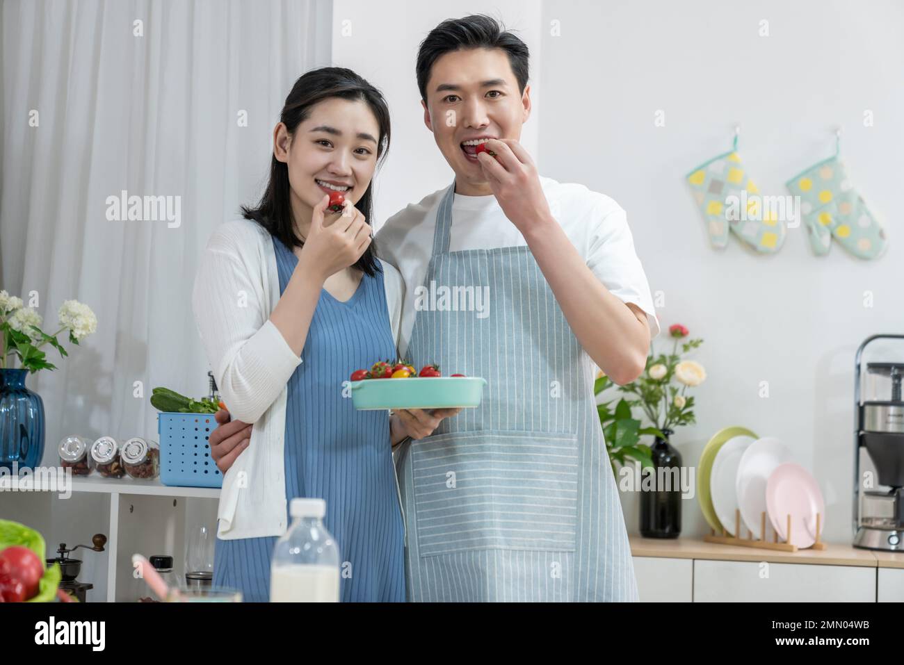 Happy young families making refreshments tablets Stock Photo - Alamy
