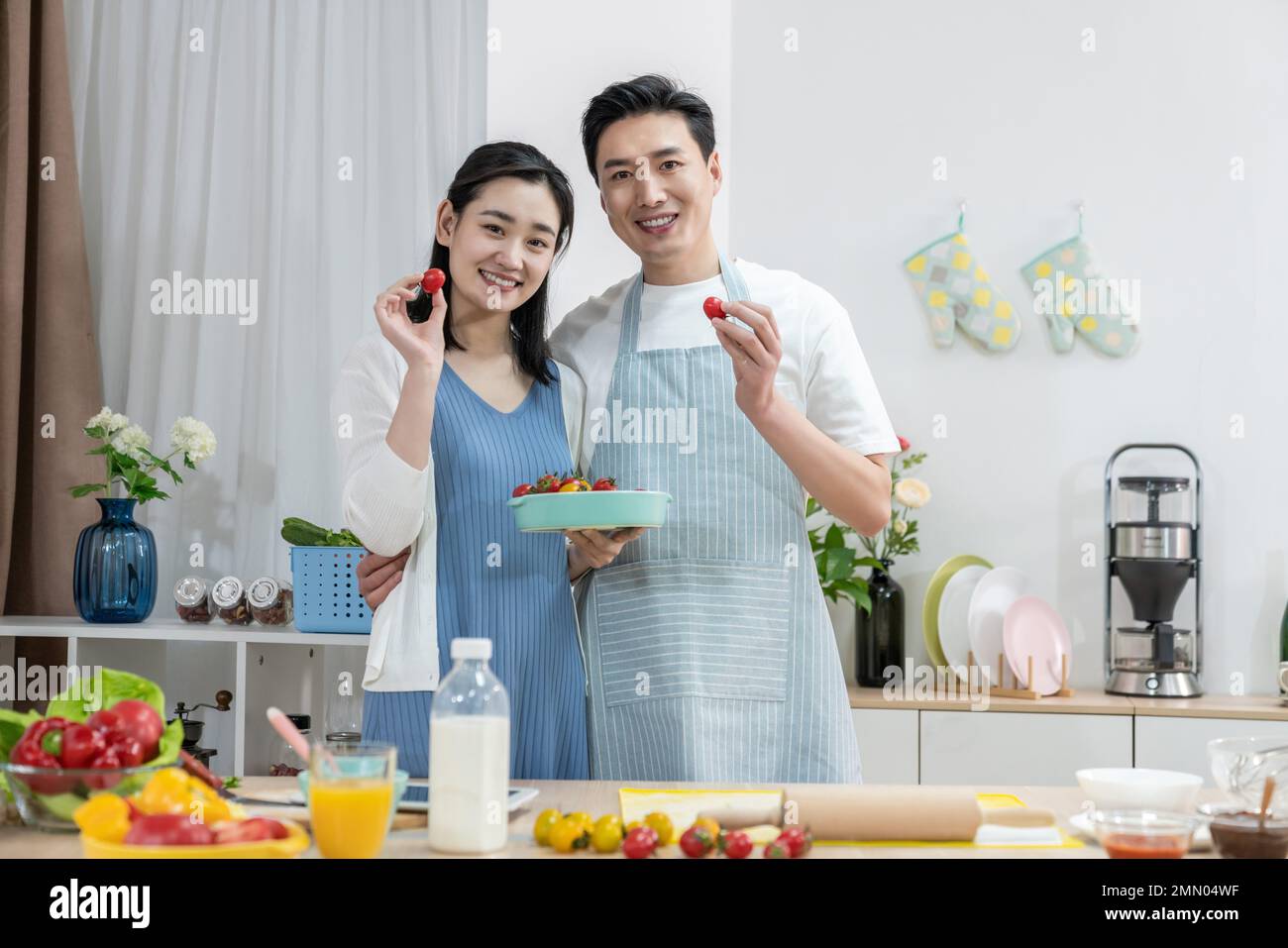 Happy young families making refreshments tablets Stock Photo - Alamy