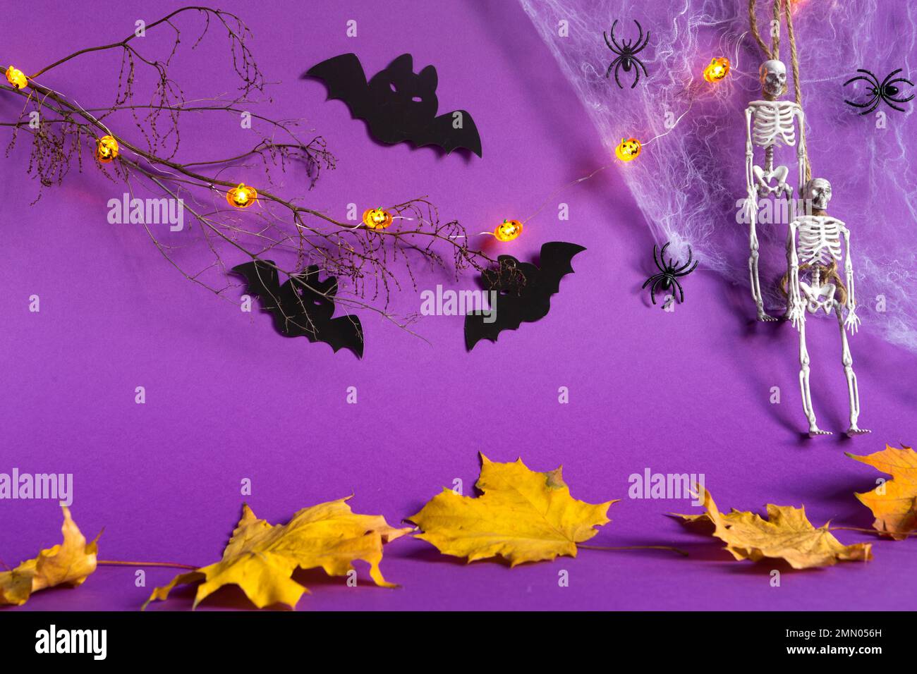 Halloween layout of garland of skeleton on a rope, glowing Jack o ...
