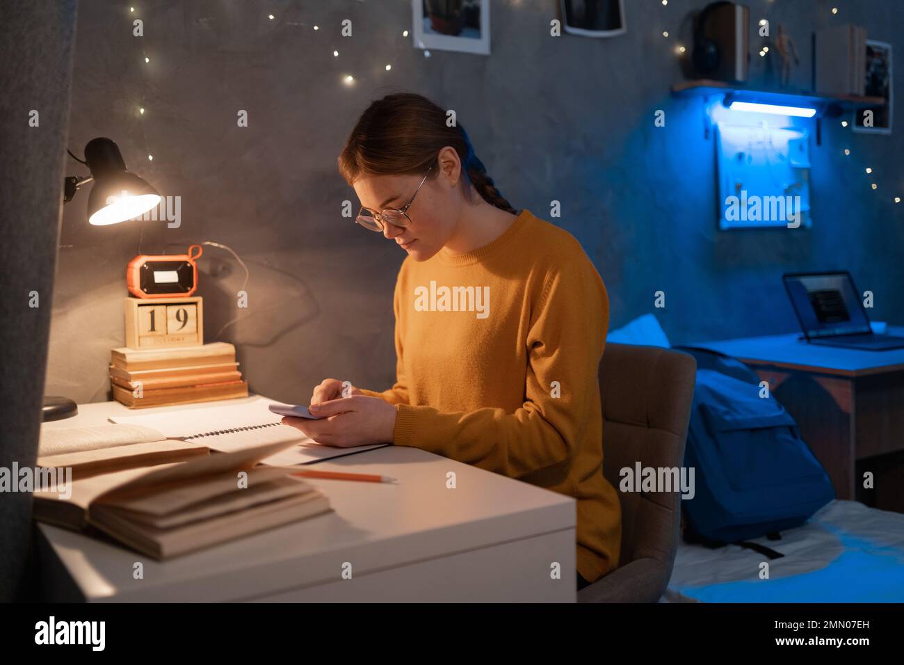 Female college student studying in dormitory at late night Stock Photo ...