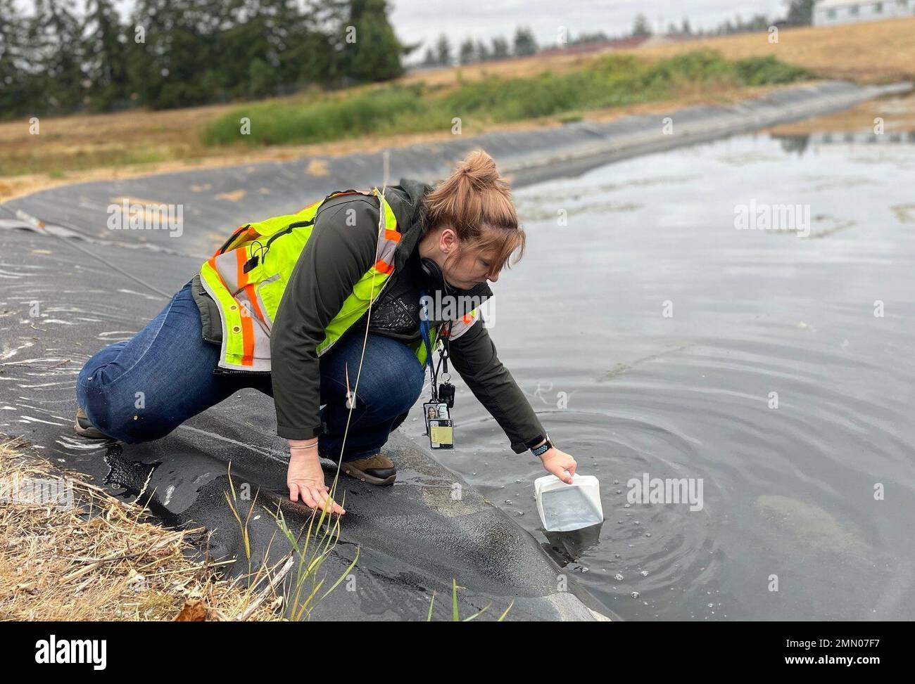 Erika Larson, stormwater technician, samples a stormwater pond on Joint ...