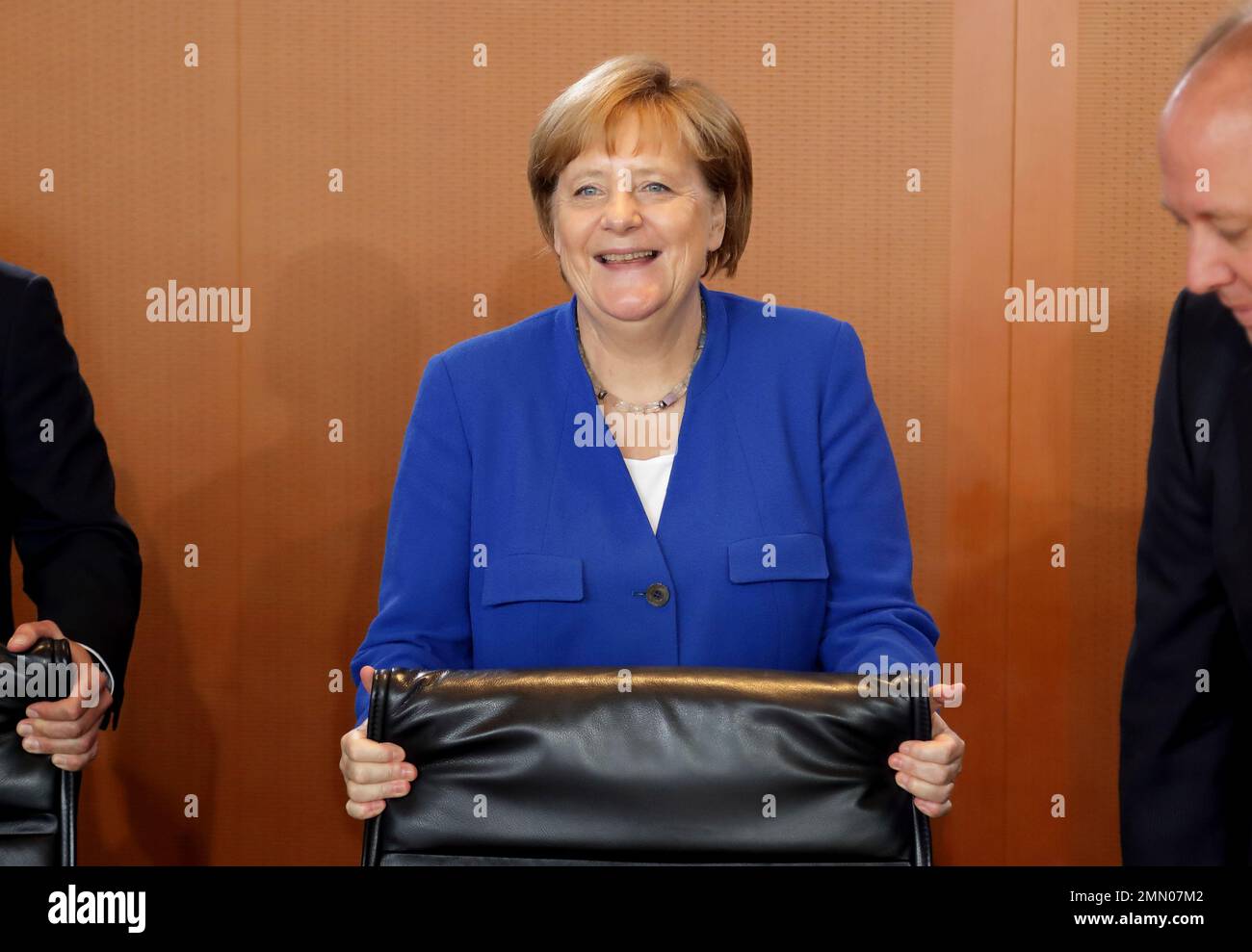 German Chancellor Angela Merkel smiles when taking her seat prior to ...