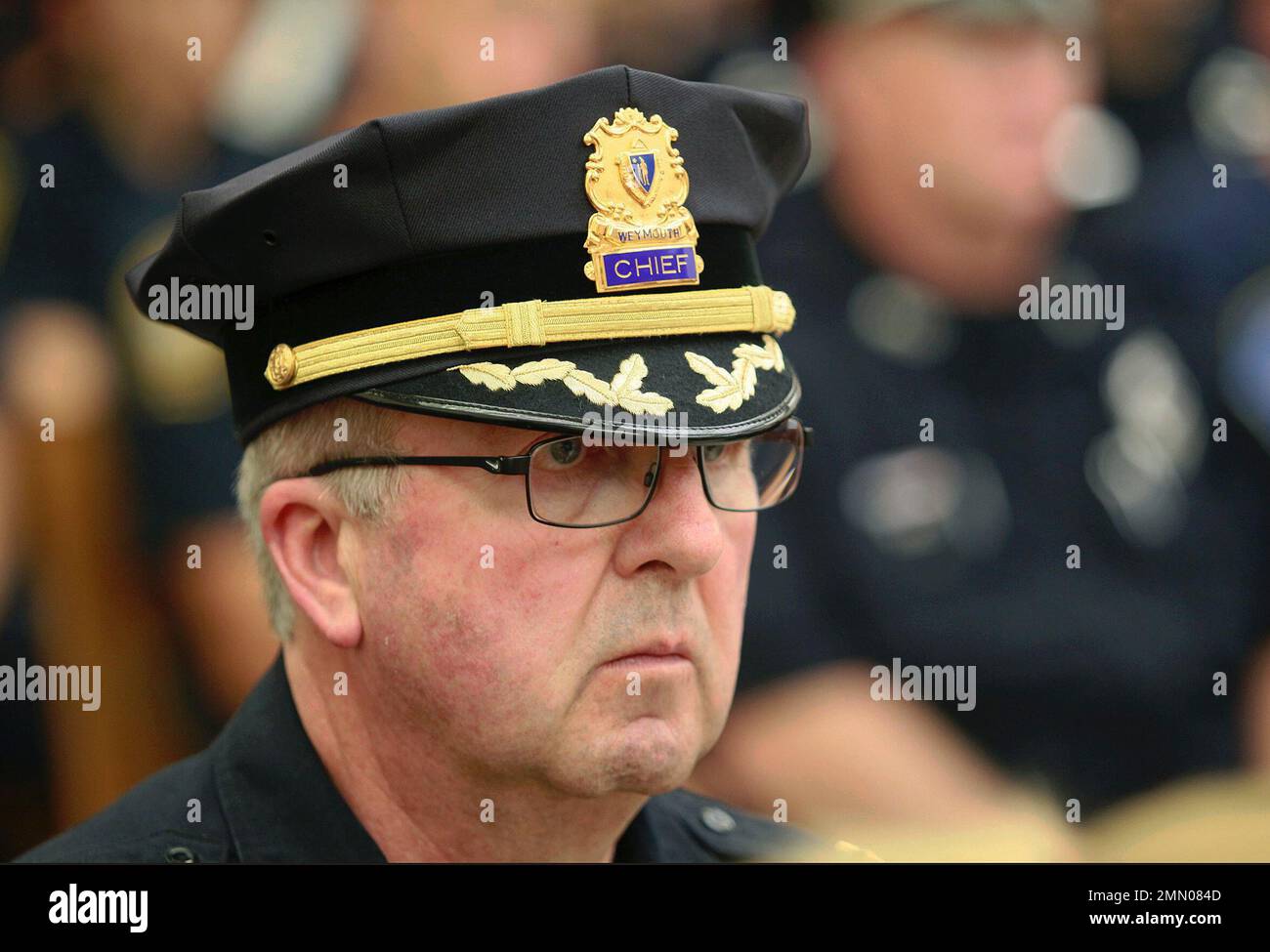 Weymouth Police Chief Richard Grimes sits with officers during the ...