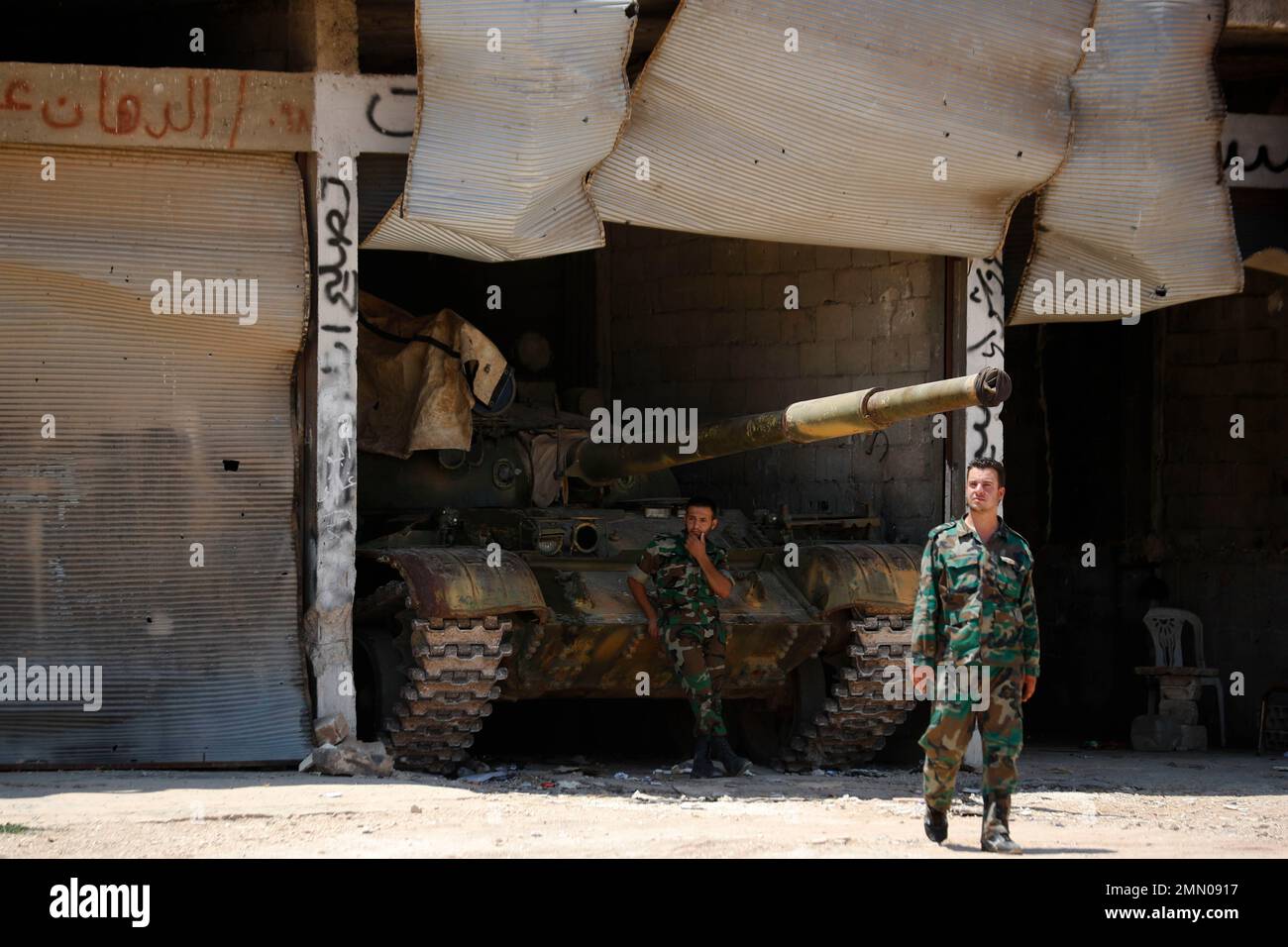 Syrian soldiers stand guard at their military post on the entrance of ...