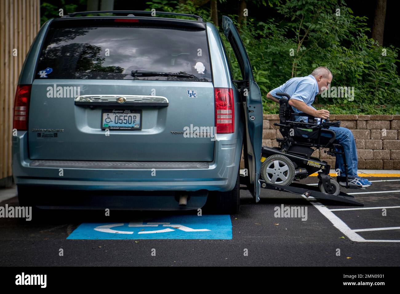 HOLD FOR STORY David Allgood drives his wheelchair up the ramp into his van after visiting a ...