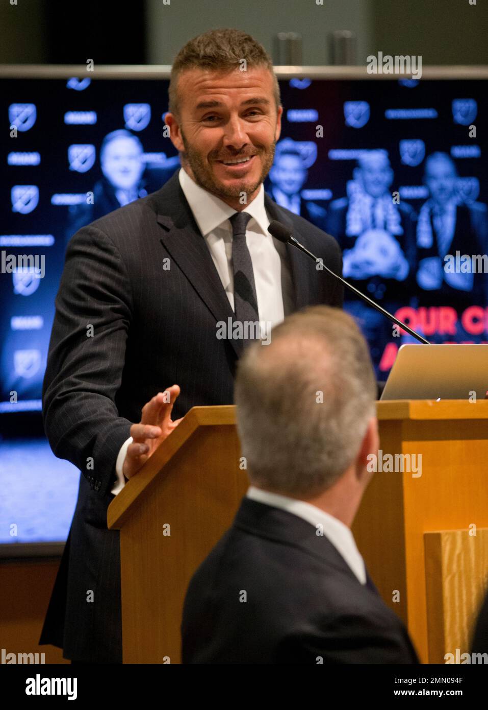David Beckham, rear, speaks as partner Jorge Mas, foreground, listens ...