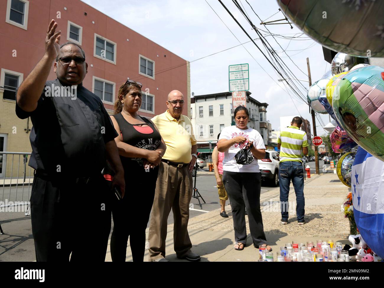 Father Nathan Aro, left, of Saints Joseph and Michael Church, gives his ...