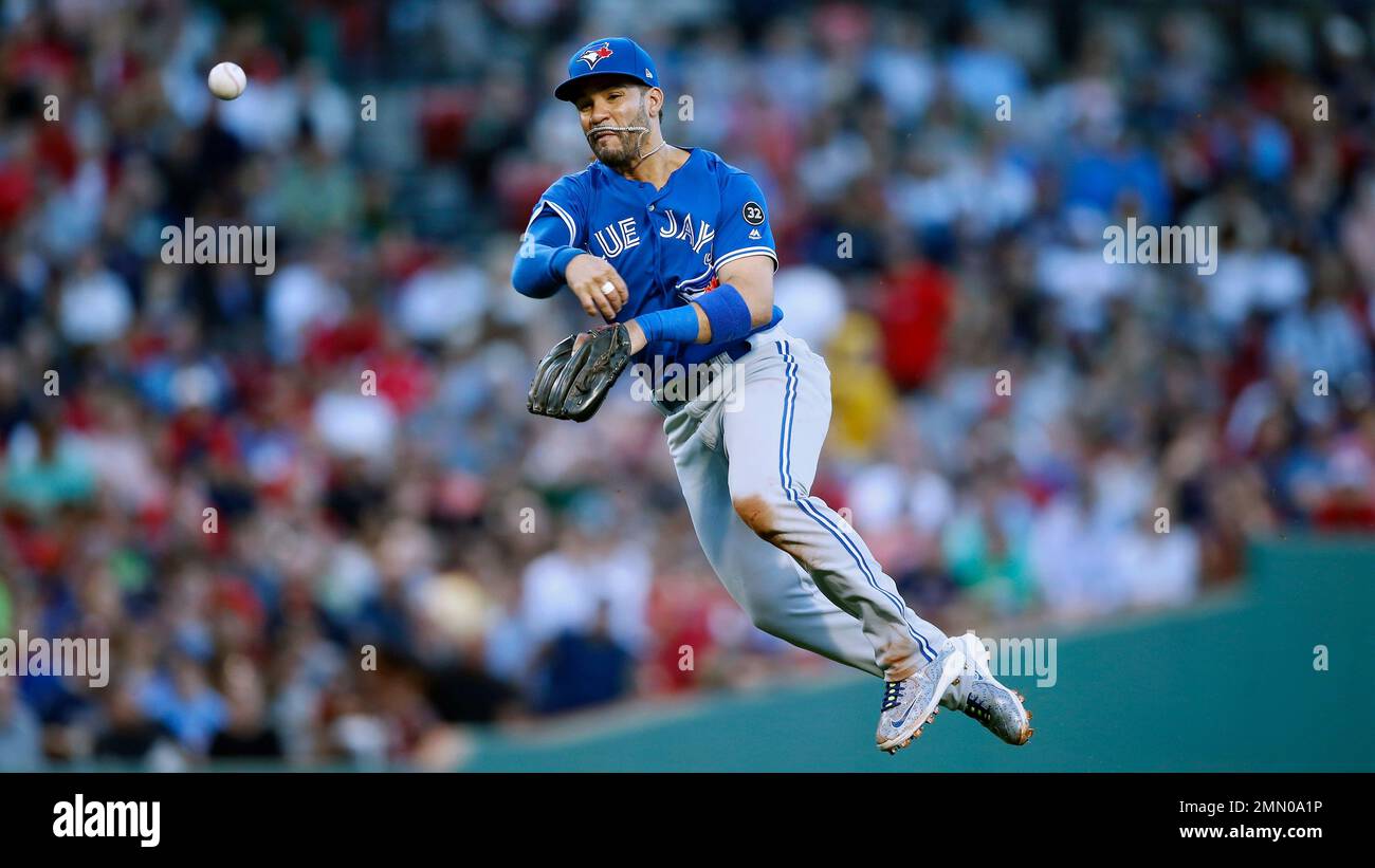Toronto Blue Jays' Devon Travis throws to first base on the ground out ...