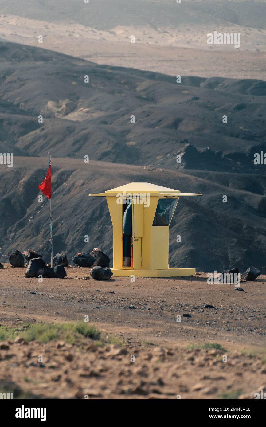 Yellow watchtower in Fuerteventura on cliff with redflag Stock Photo ...