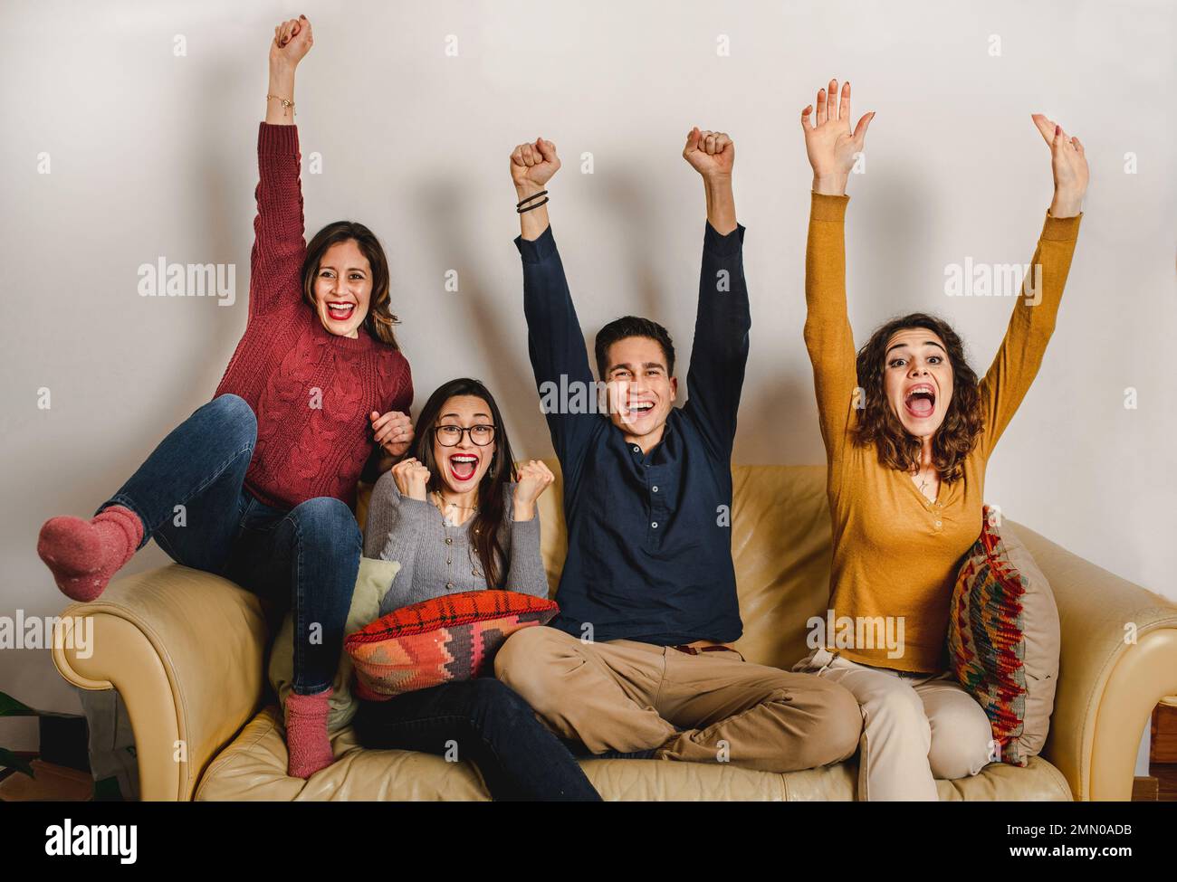 Group of excited friends watching football match and celebrating ...