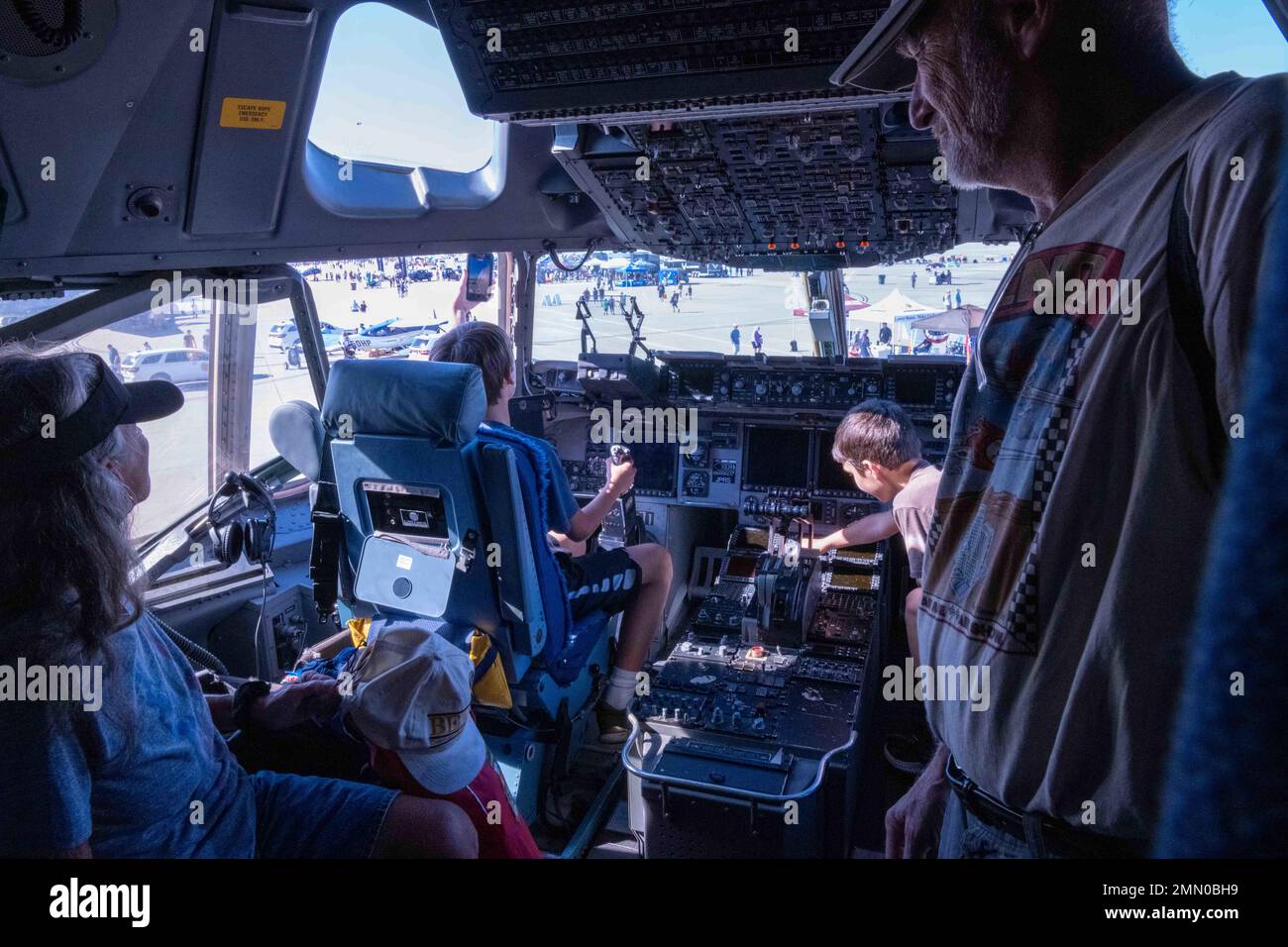Children and adults gather in the cockpit of a KC-135 Stratotanker as ...
