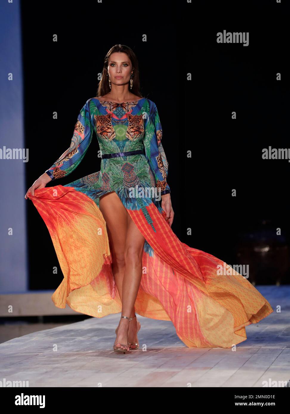 A model walks down the runway during the Fashion Palette Miami ...