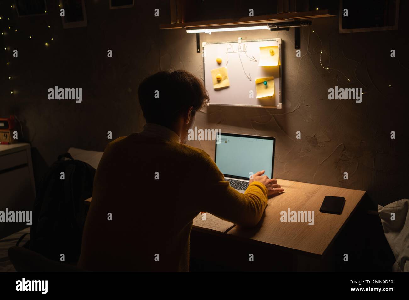 Arabic university student in dorm working on laptop at the late night ...