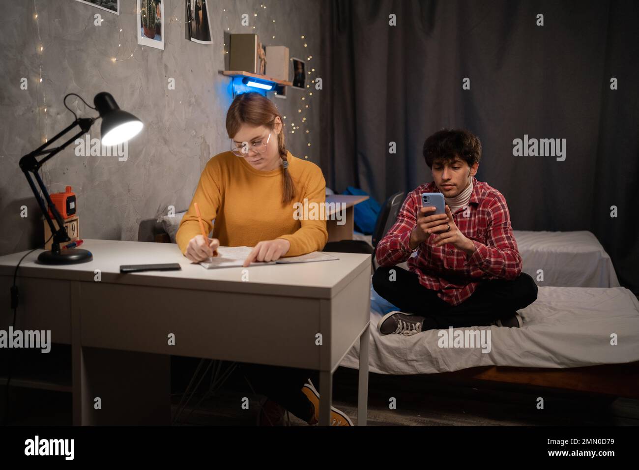 Serious college students studying in dormitory at night Stock Photo - Alamy