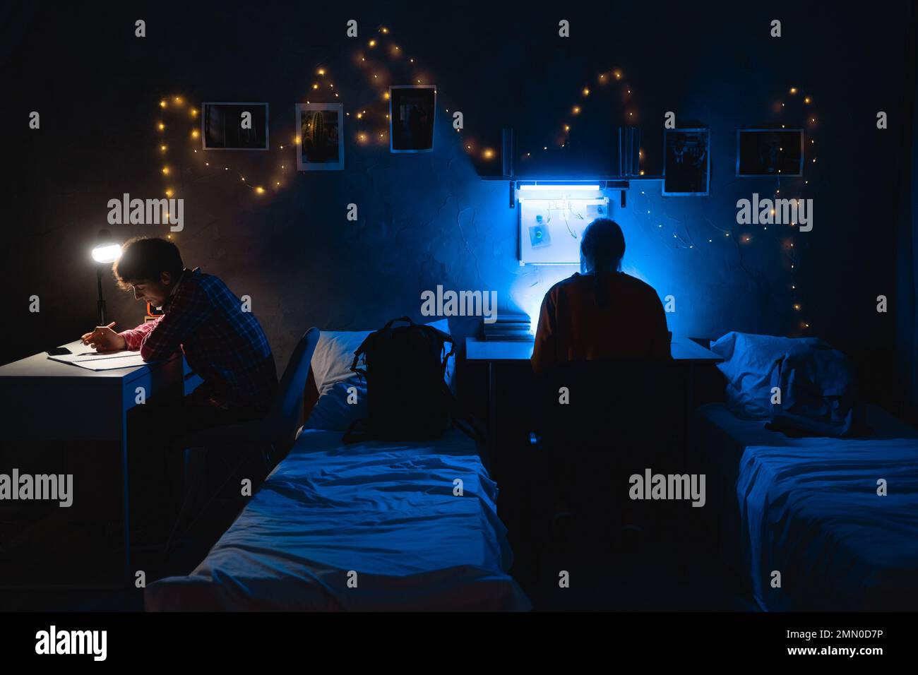 Serious college students studying in dormitory at night Stock Photo - Alamy