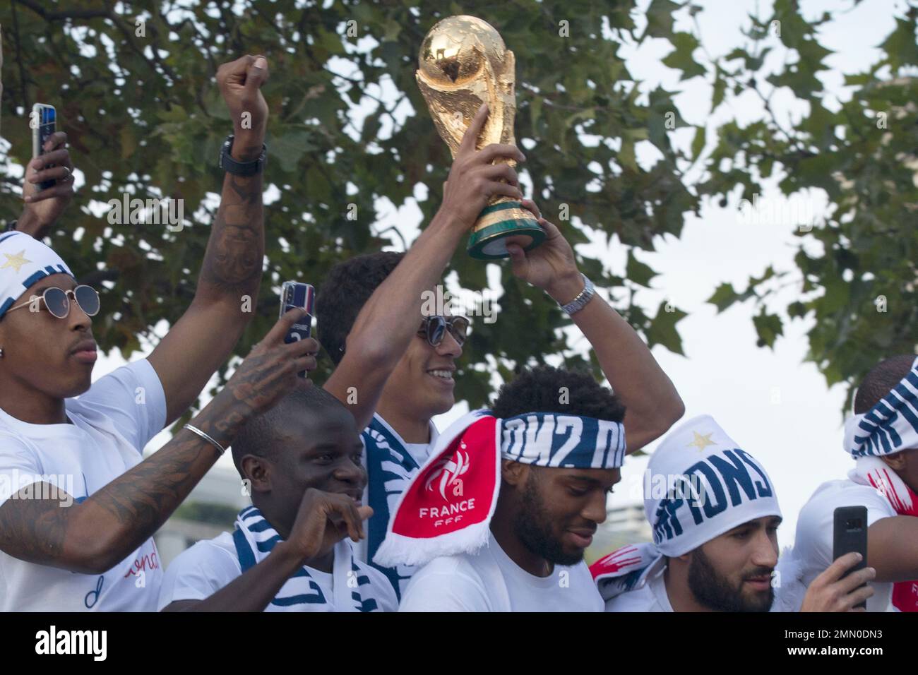 French soccer defender Raphael Varane holds up the World Cup trophy as ...
