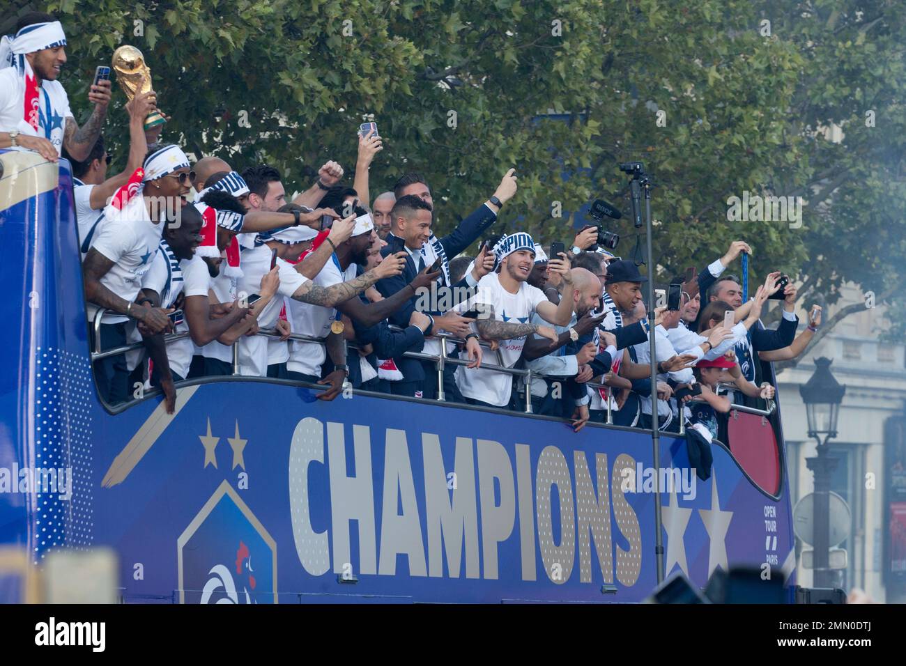 The victorious French World Cup soccer team waves from a bus during a ...