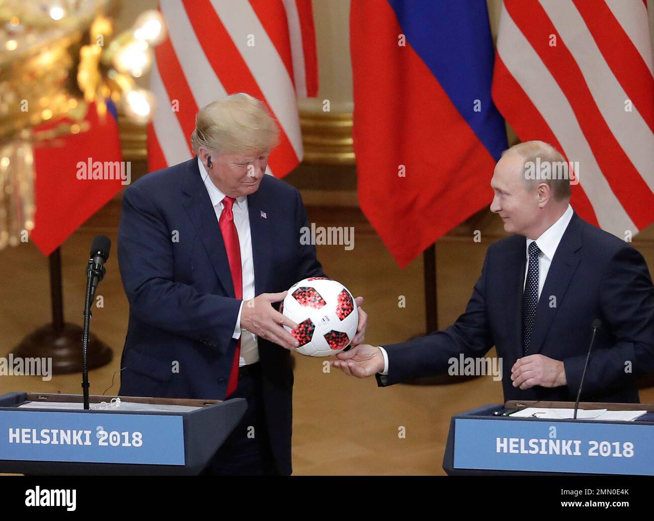 Russian President Vladimir Putin gives a soccer ball to U.S. President ...