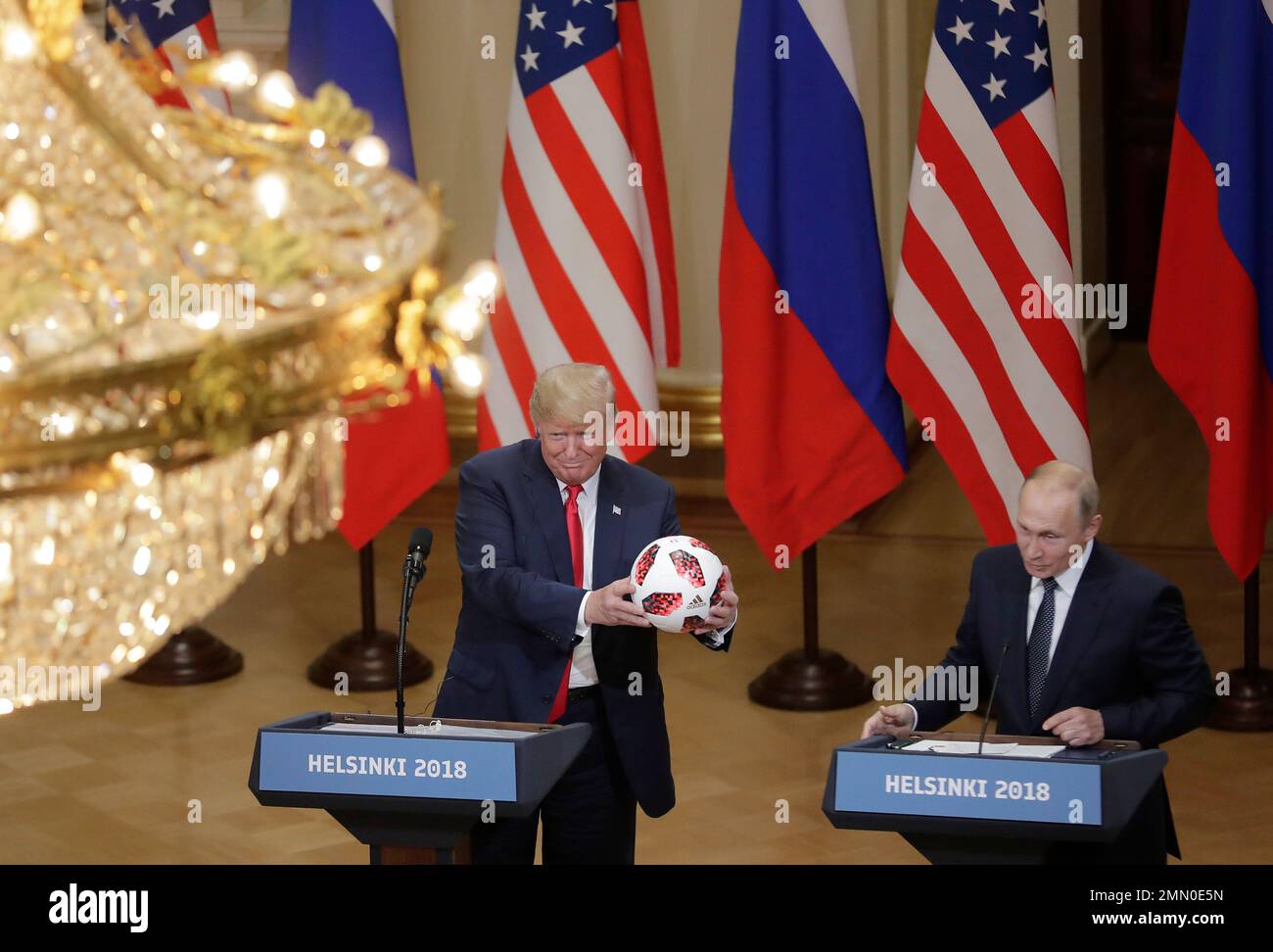 Russian President Vladimir Putin gives a soccer ball to U.S. President ...