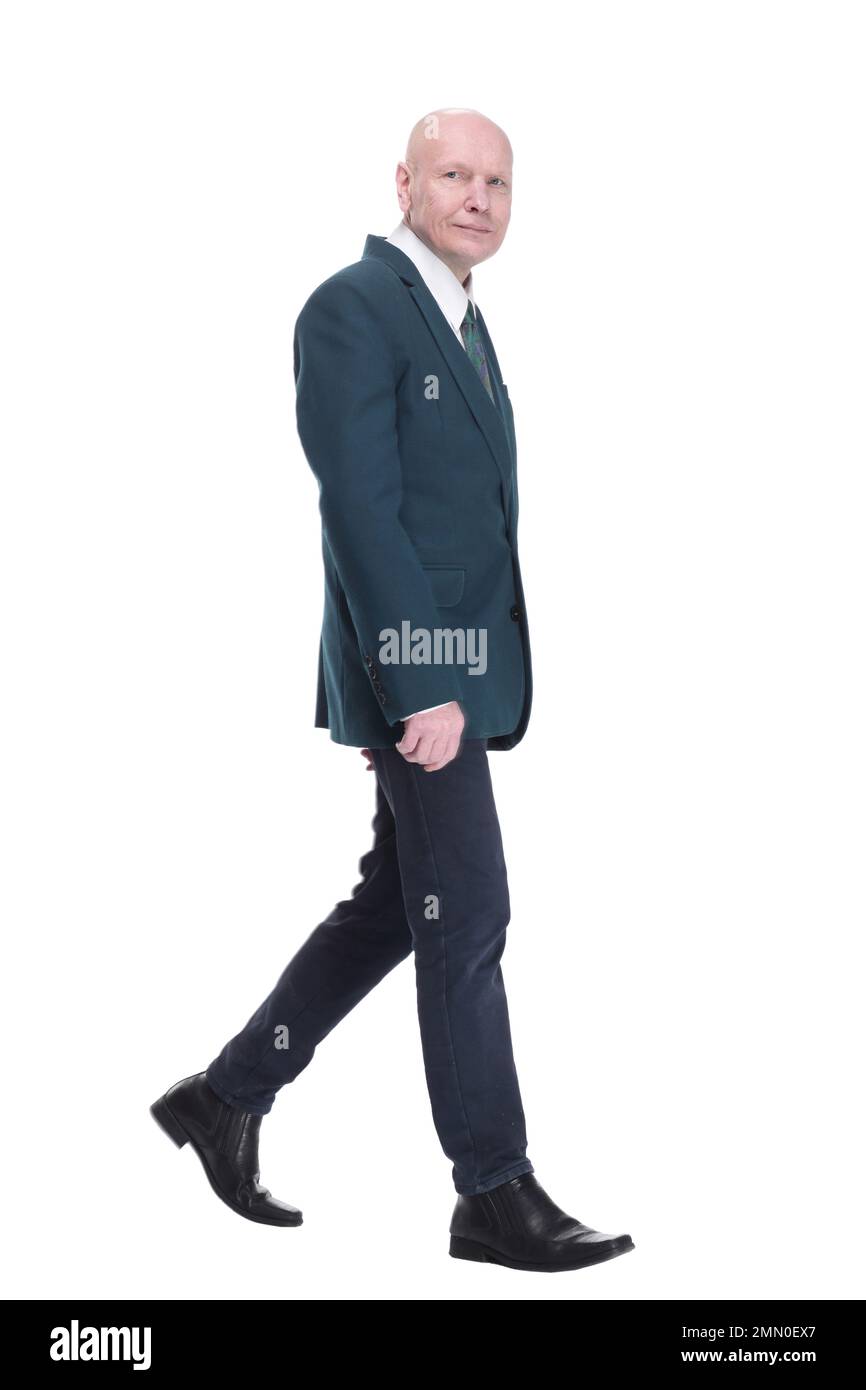 Mature business man striding forward. isolated on a white background ...
