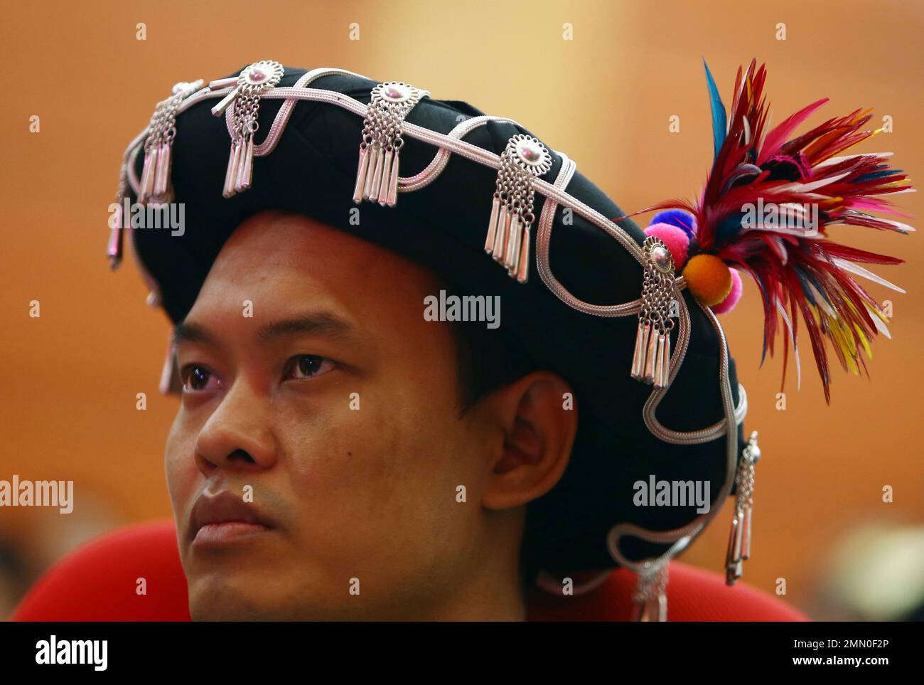 An Akha ethnic man in the traditional costume attends the closing ...