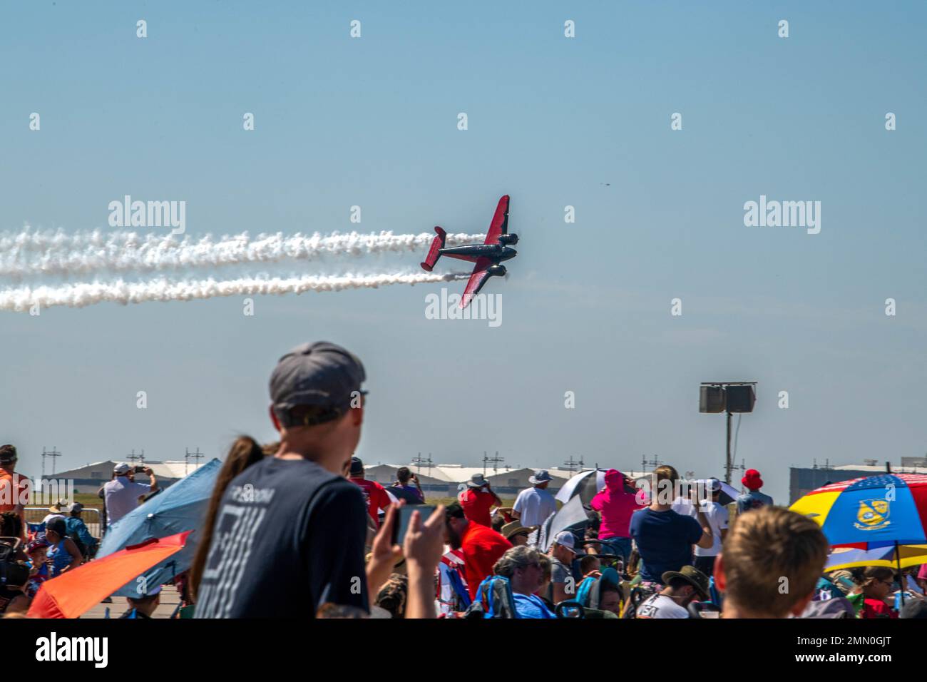 Visitors watch Matt Younkin perform in his Beech-18 during the ...