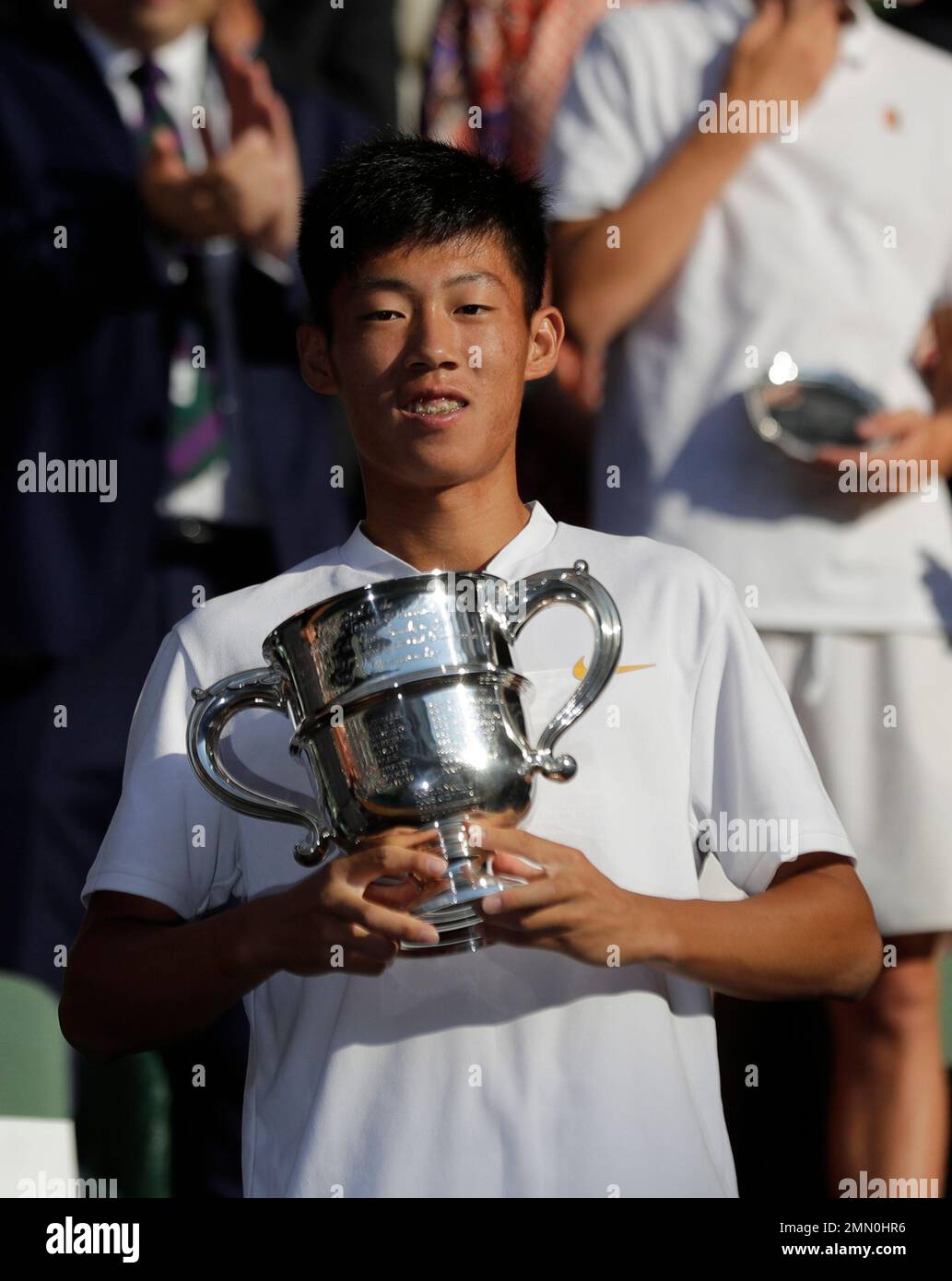 Tseng Chun Hsin of Taiwan holds the trophy after defeating Jack Draper ...