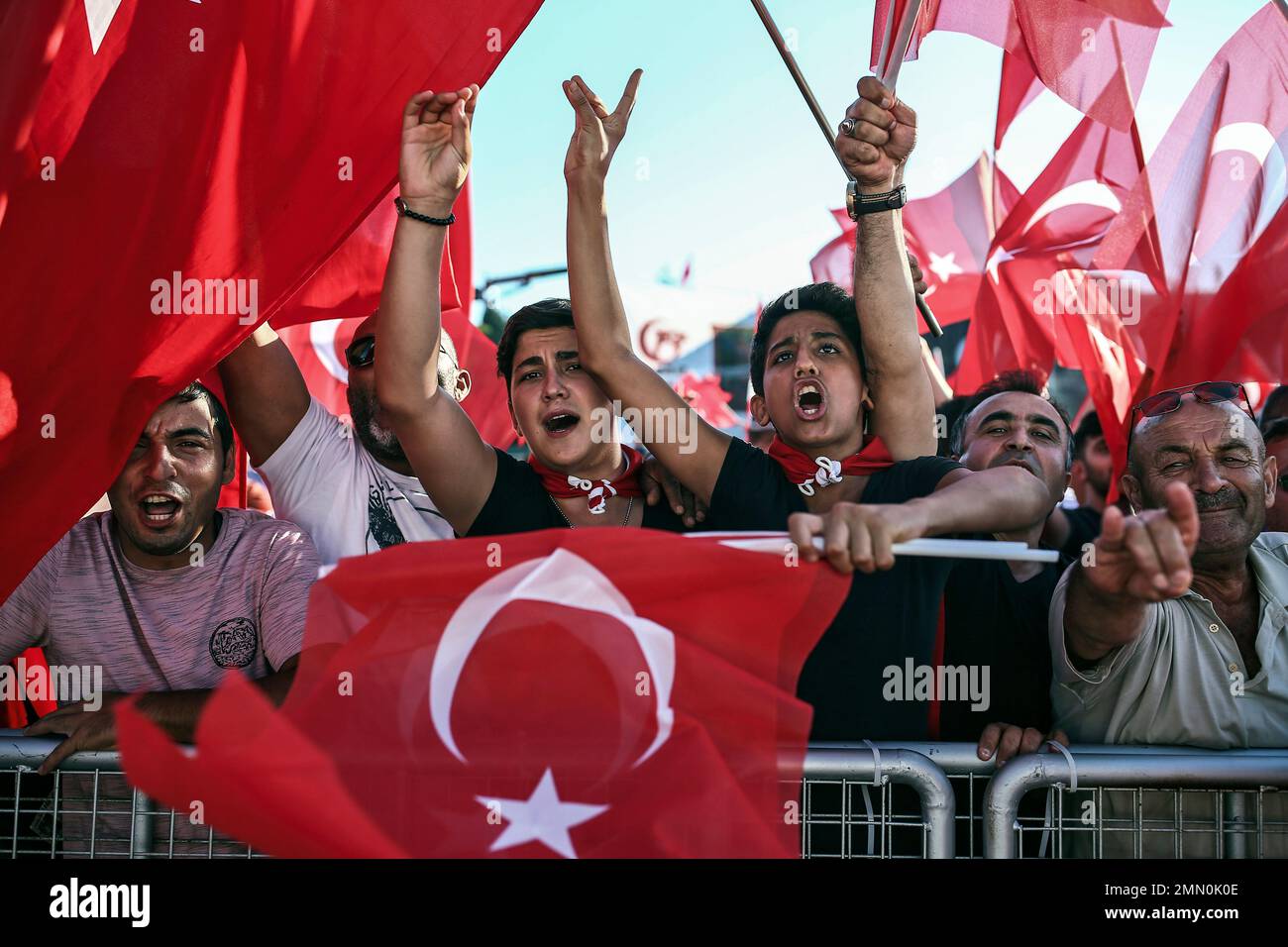 People chant slogans and wave Turkish flags prior to a commemoration ...
