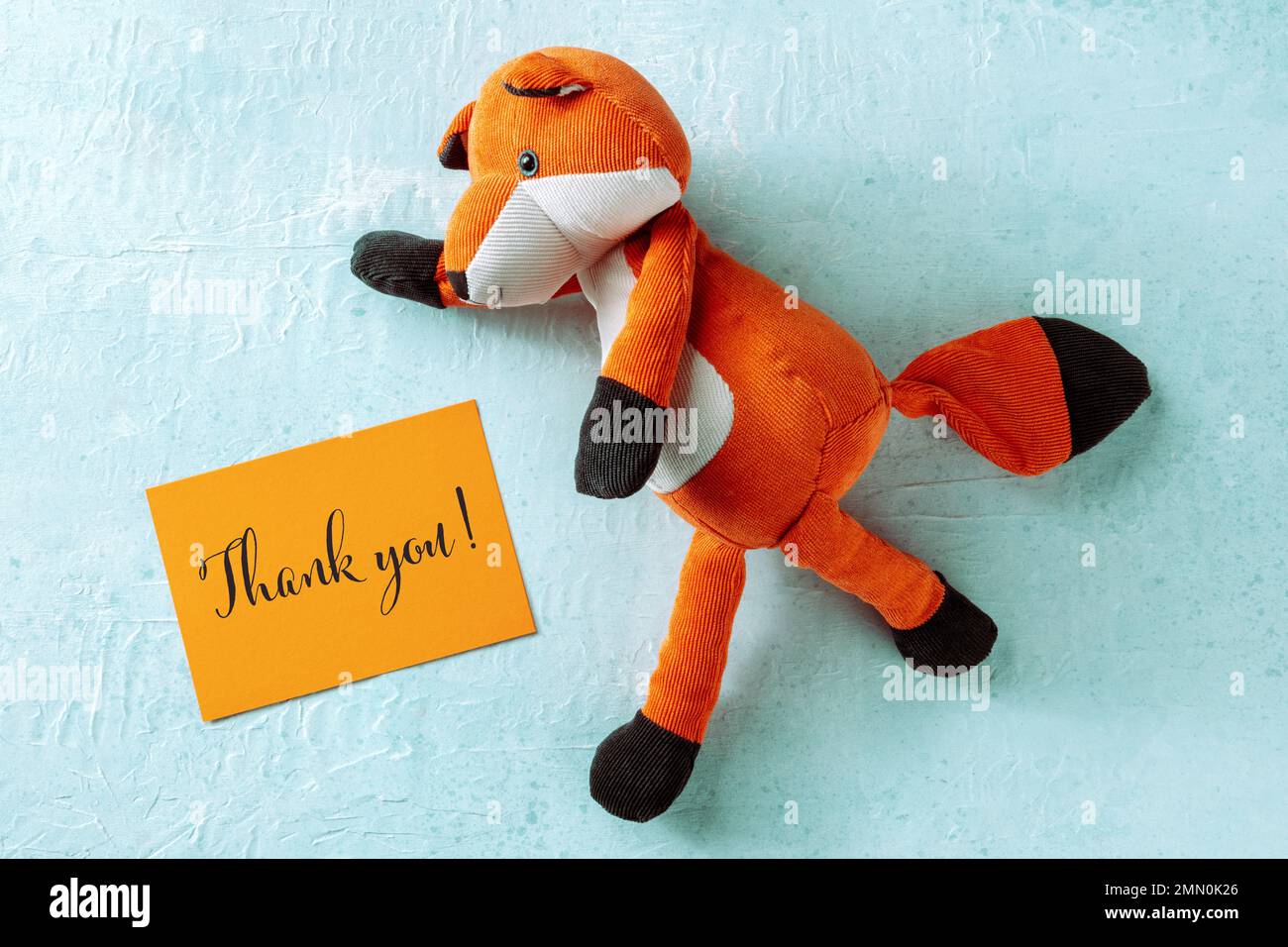 Thank you card with a toy fox, orange paper and blue background Stock ...