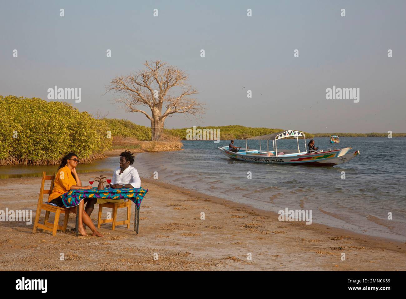Senegal, Saloum delta listed as World Heritage by UNESCO, couple seated ...