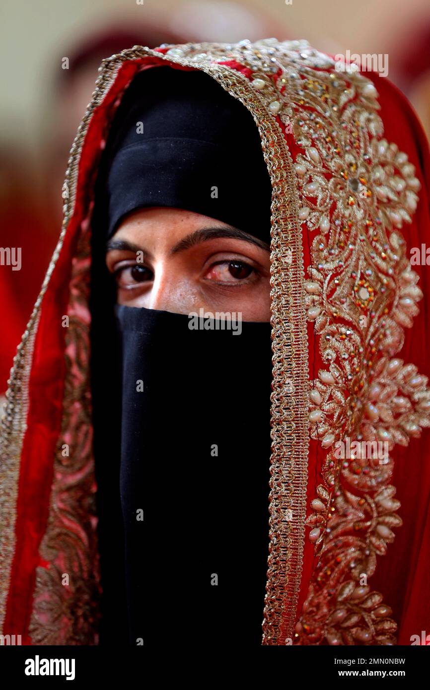 A Kashmiri Shiite Muslim bride looks on at a mass marriage event in ...