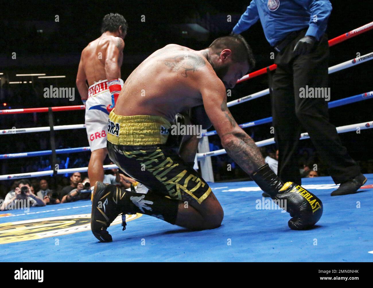 Lucas Matthysse of Argentina falls after receiving a punch by Manny ...