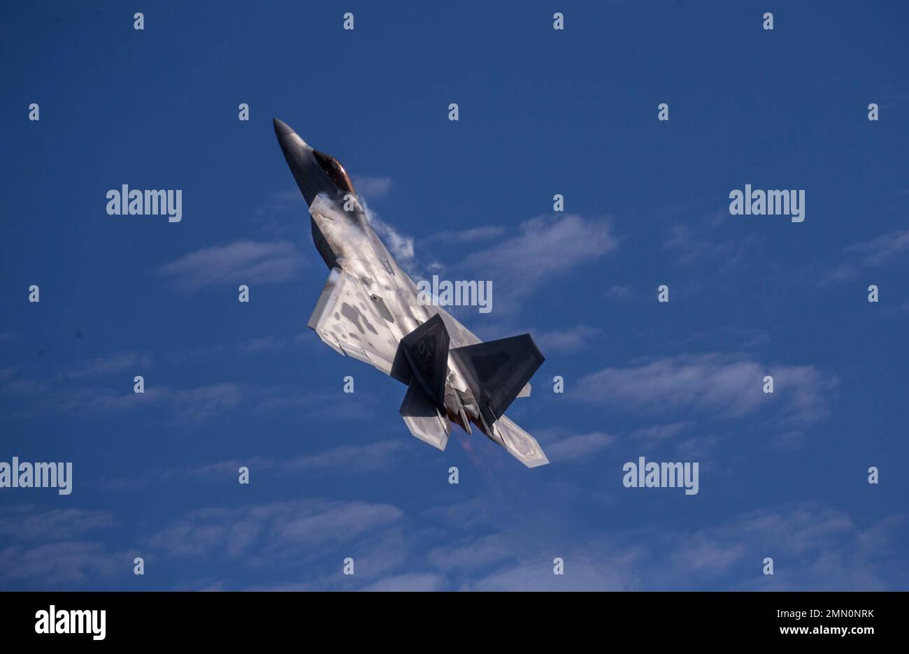 A U.S. Air Force F-22 Raptor conducts a heritage flight during the 2022 ...