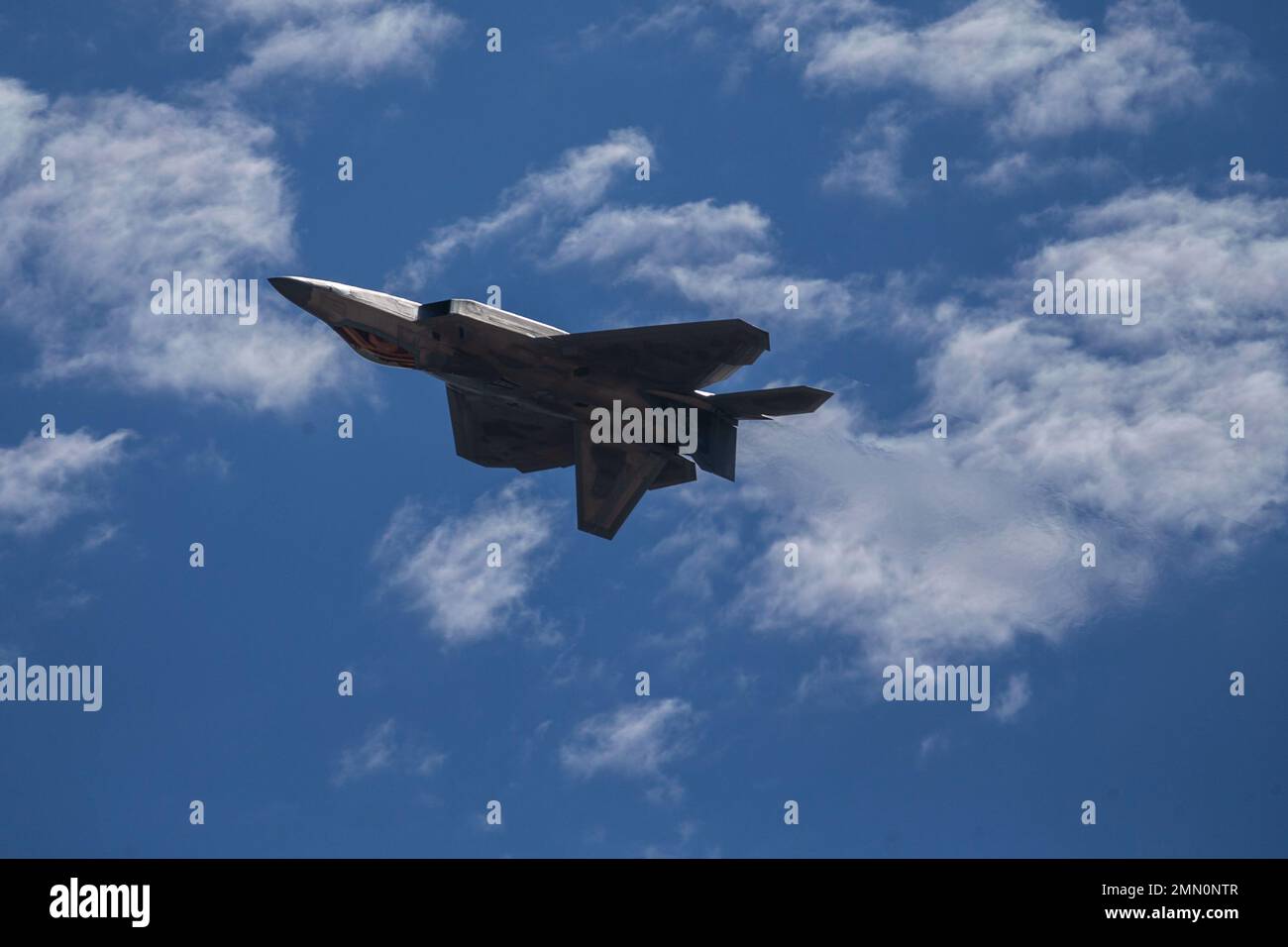 A U.S. Air Force F-22 Raptor conducts a heritage flight during the 2022 ...