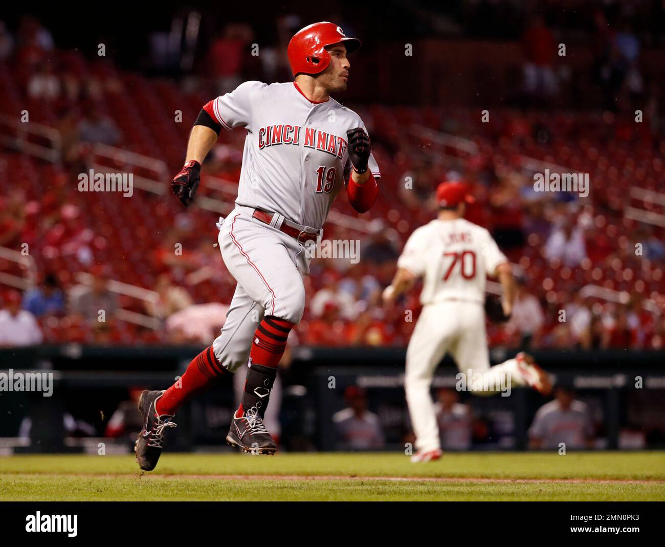 Cincinnati Reds' Joey Votto, left, heads to first after hitting a two ...