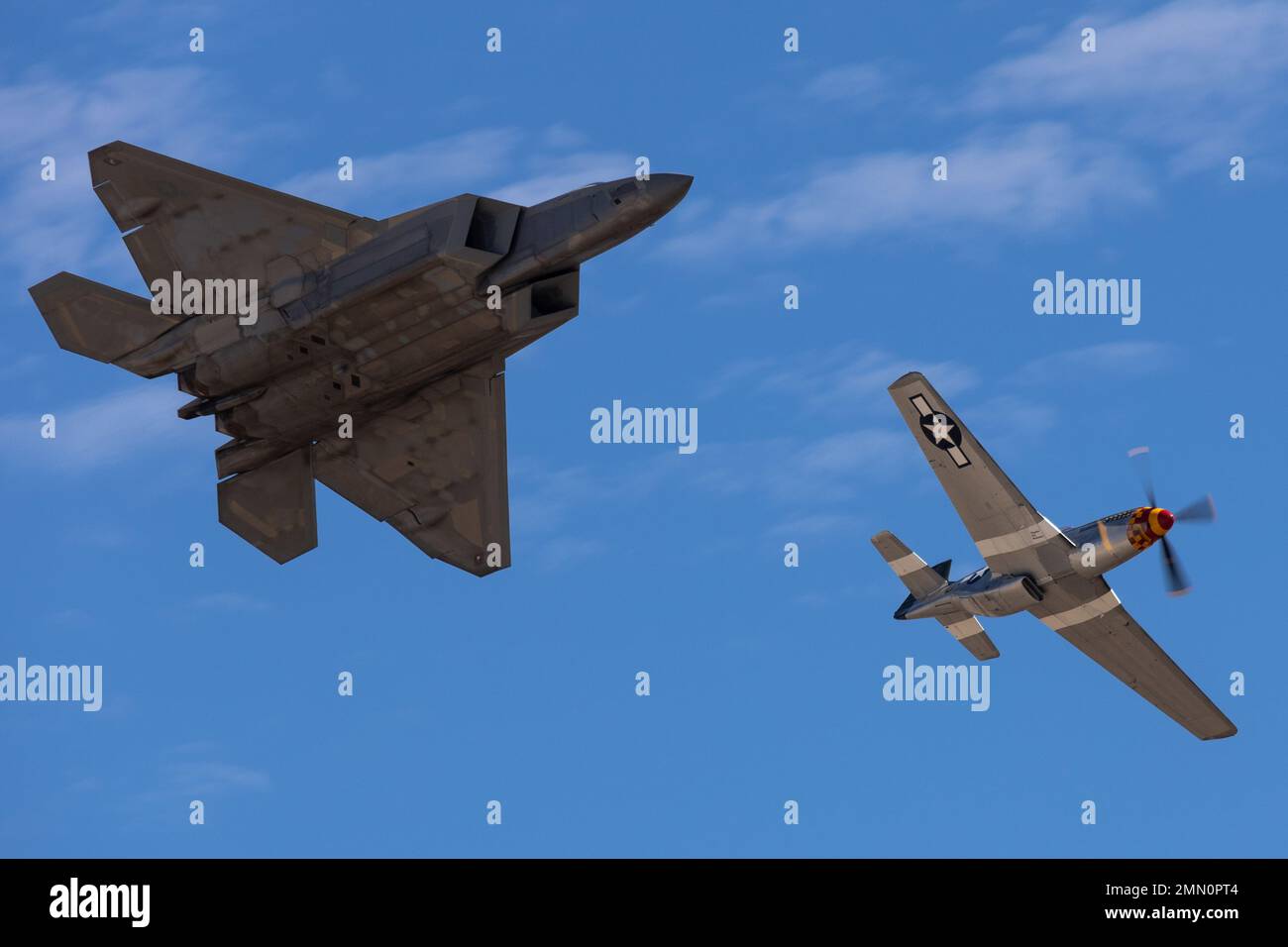 A U.S. Air Force F-22 Raptor and a P-51D Mustang conduct a heritage ...