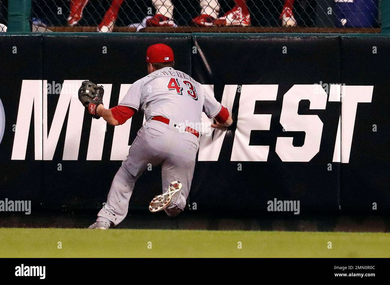 Cincinnati Reds right fielder Scott Schebler slams into the outfield ...