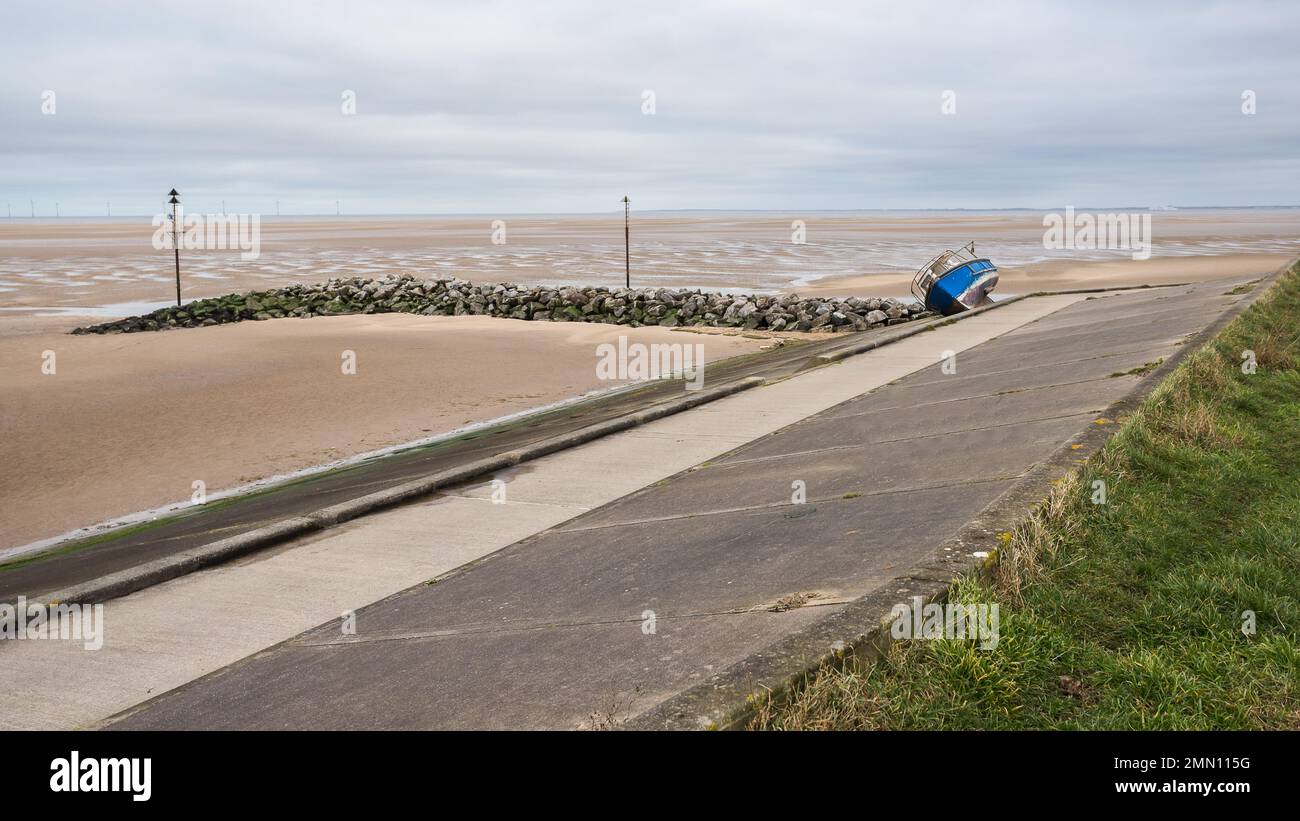 An abandoned boat seen on the slanted concrete sea shore at Meols on ...