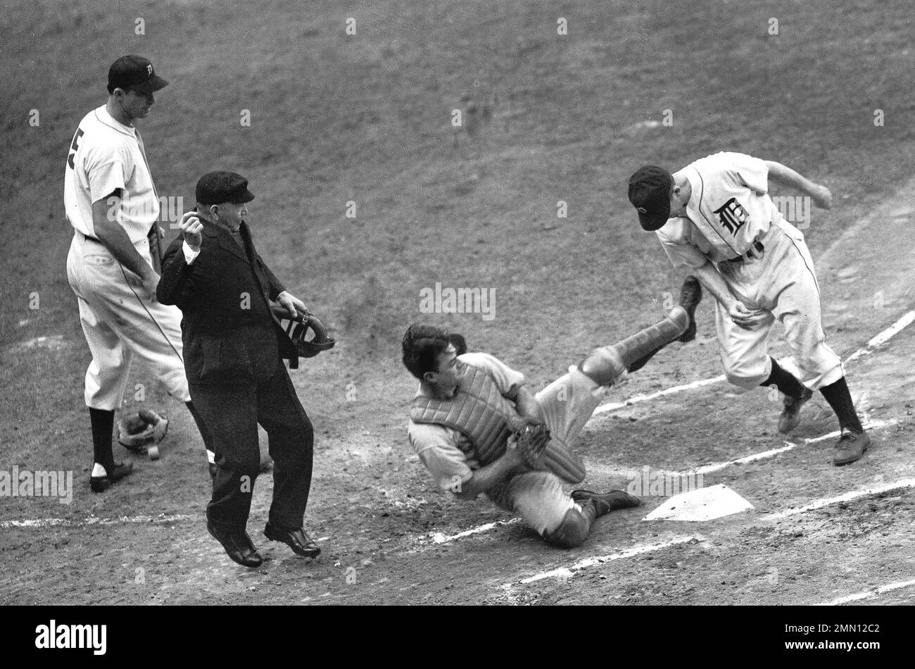 Jimmy Wilson, Cincinnati Reds catcher, holds onto ball while sprawled ...