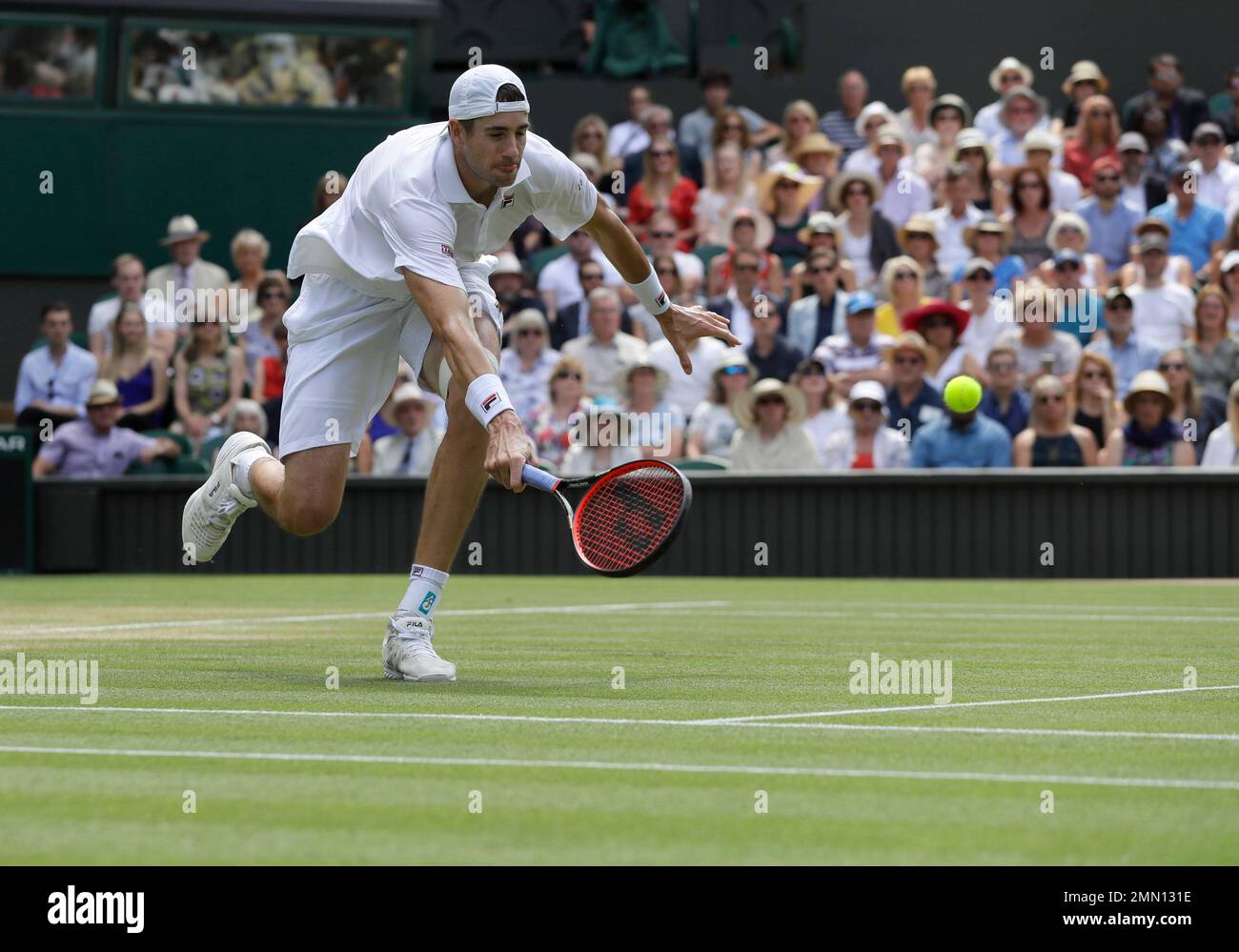John Isner of the United States returns the ball to South Africa's ...