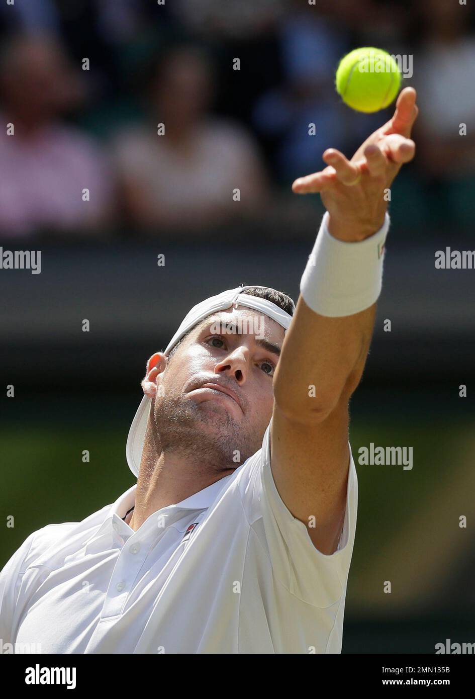 John Isner of the United States serves to South Africa's Kevin Anderson ...