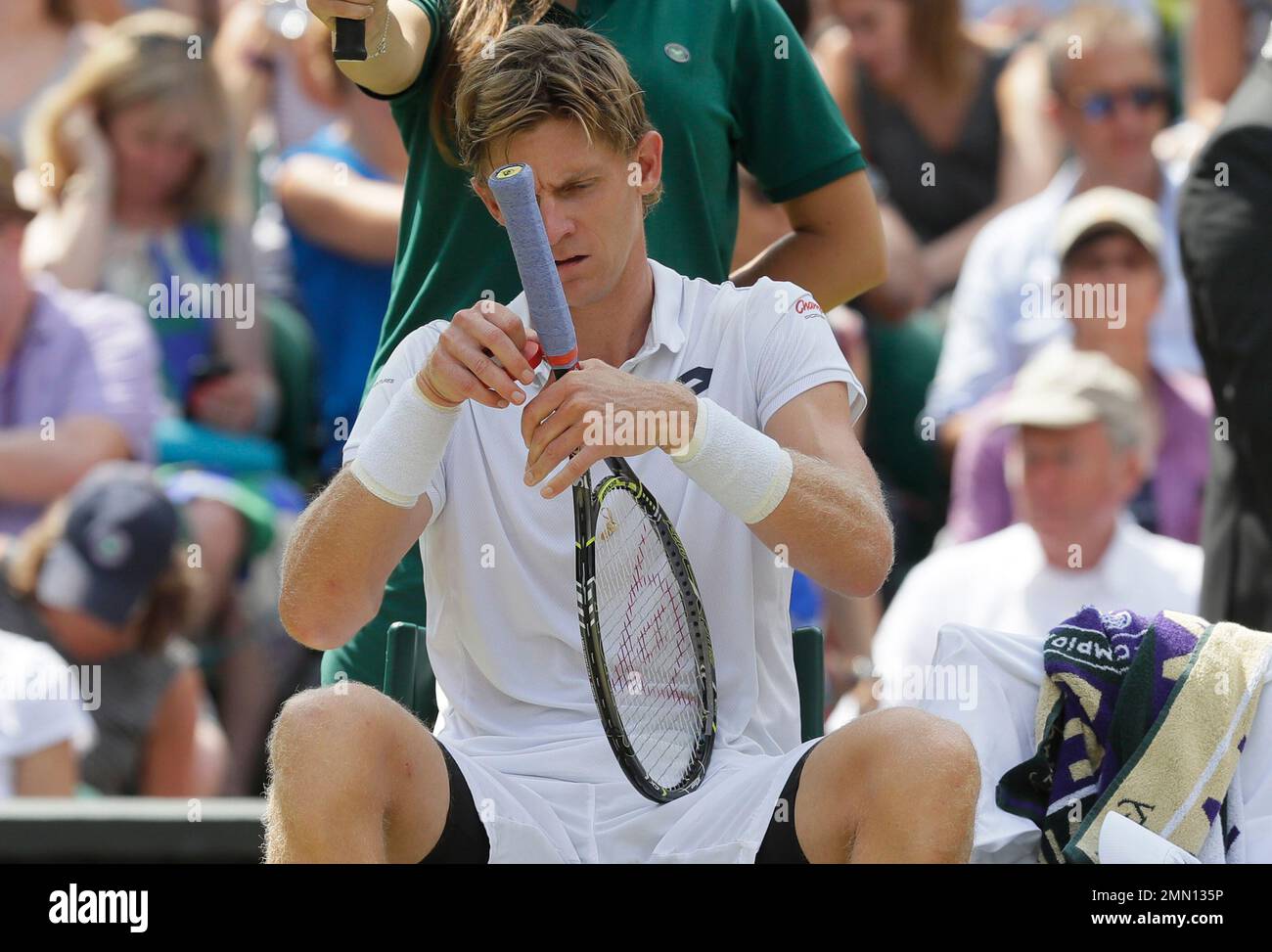 South Africa's Kevin Anderson tapes the handle of his racket during a ...