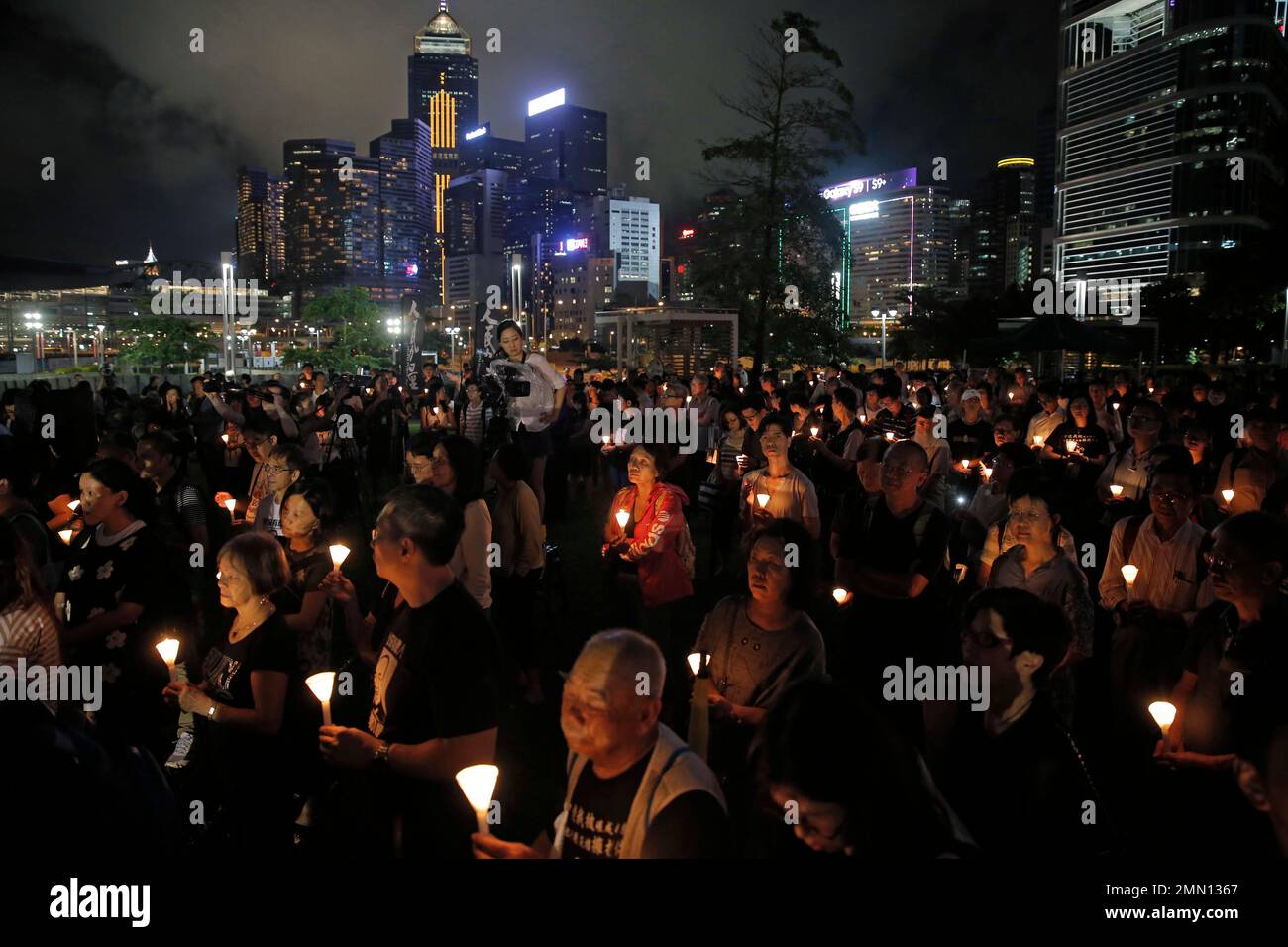 People attend a candlelight vigil to mourn the late Chinese Nobel Peace laureate Liu Xiaobo in ...