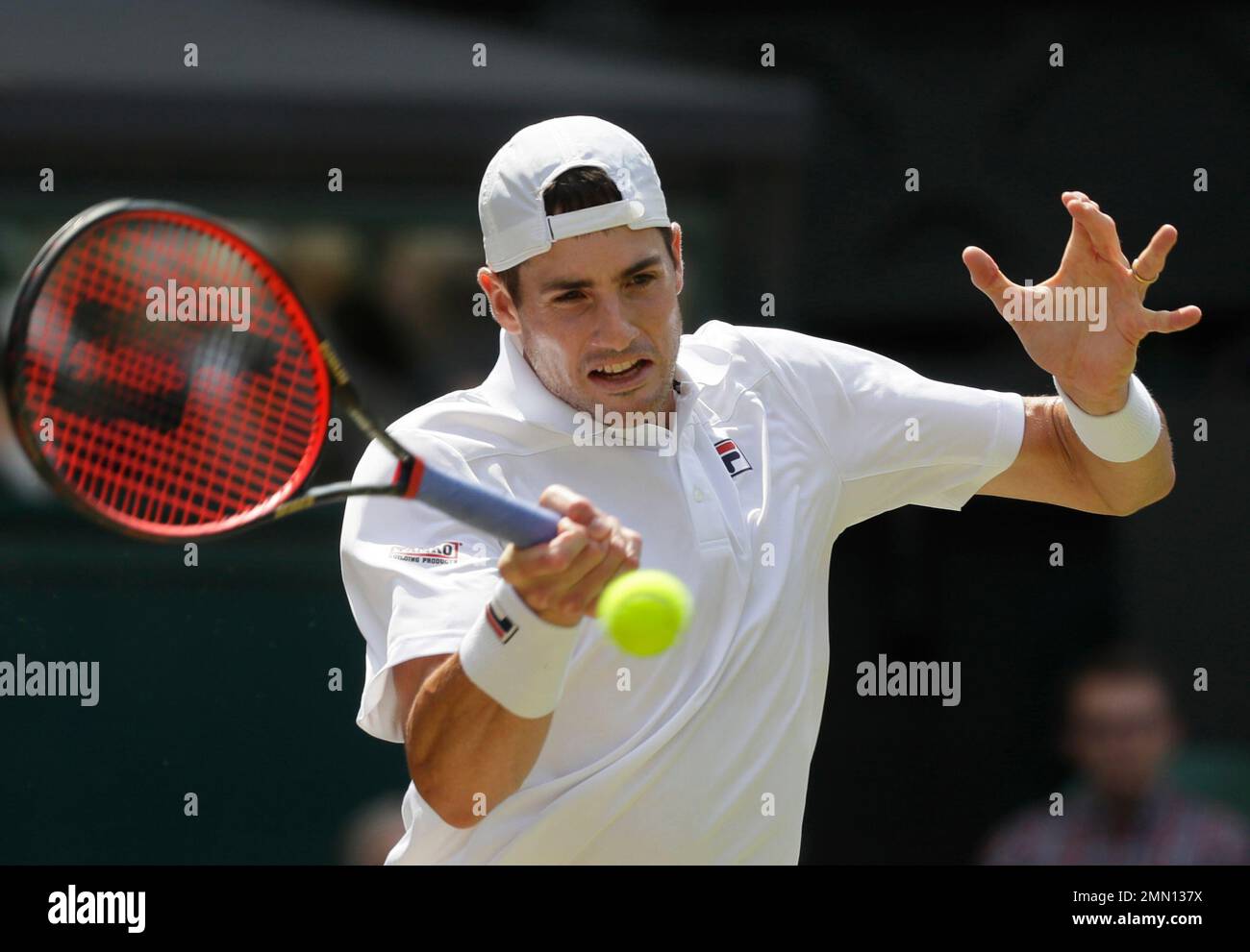 John Isner of the United States returns the ball to South Africa's ...