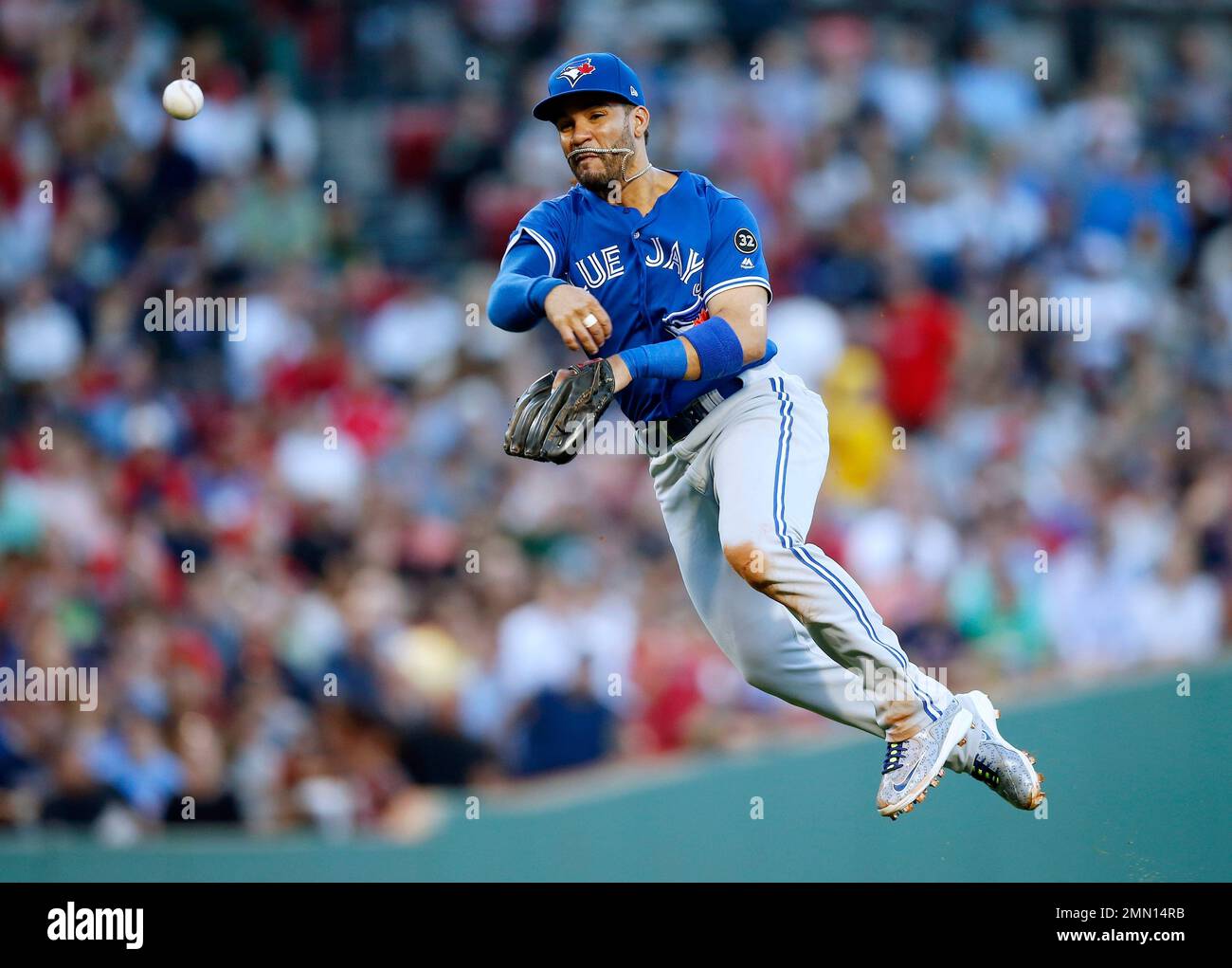 Toronto Blue Jays' Devon Travis throws to first base for the out on a ...