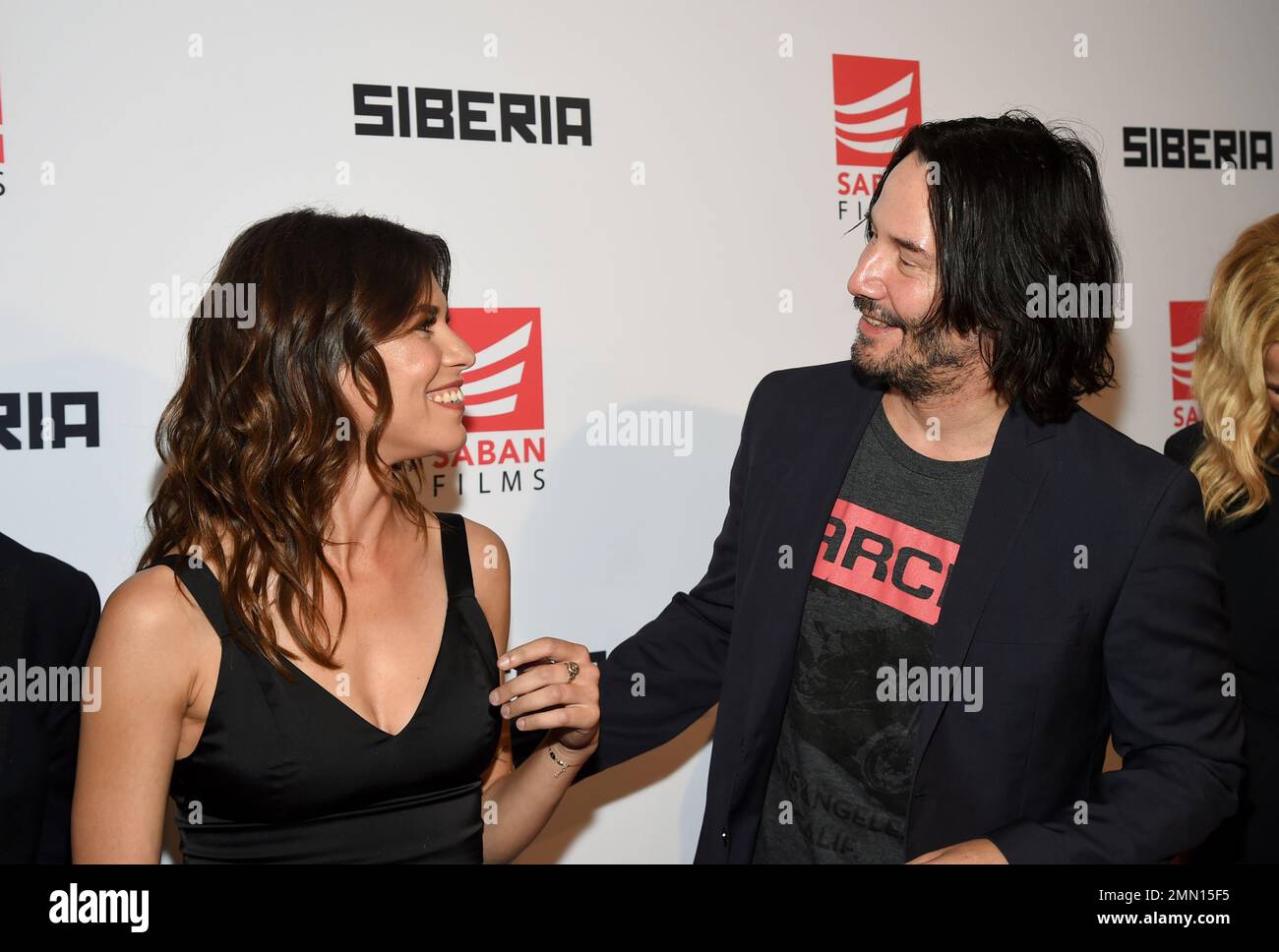 Actors Ana Ularu, left, and Keanu Reeves greet each other at the ...
