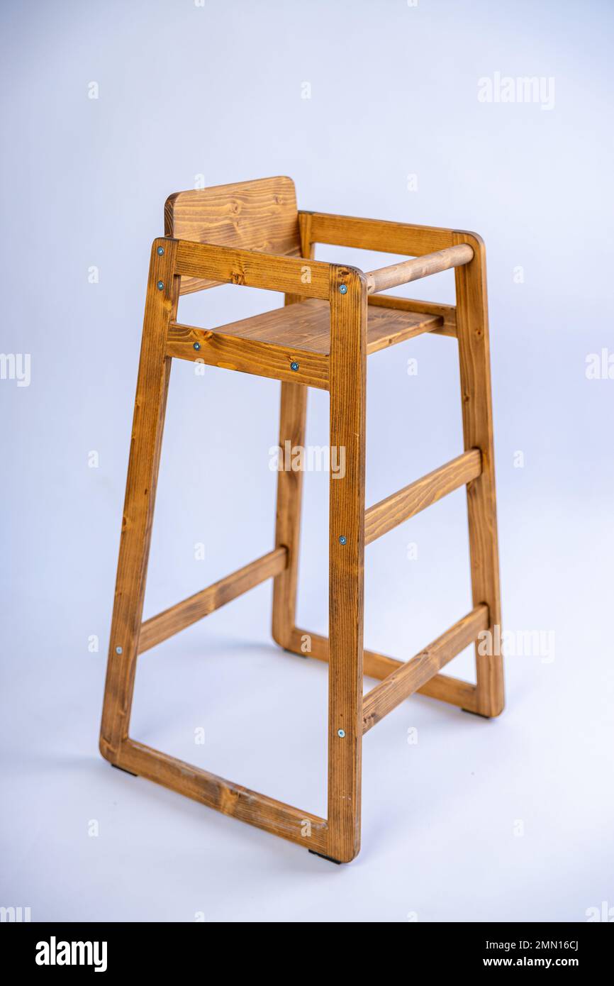 Wooden handmade high chair on white background in a studio. High ...